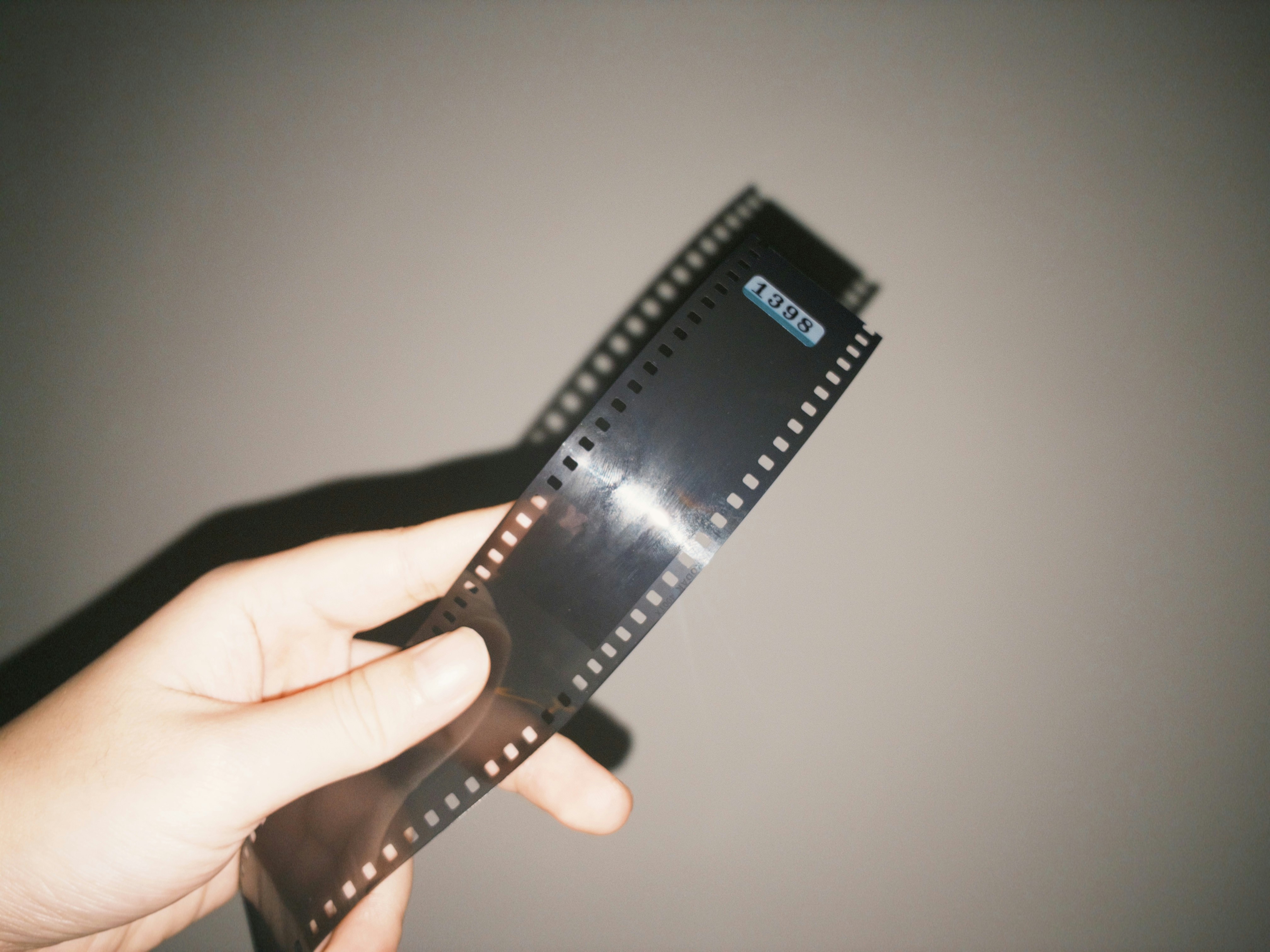 A Strip of Film Gripped by a Gentle Hand