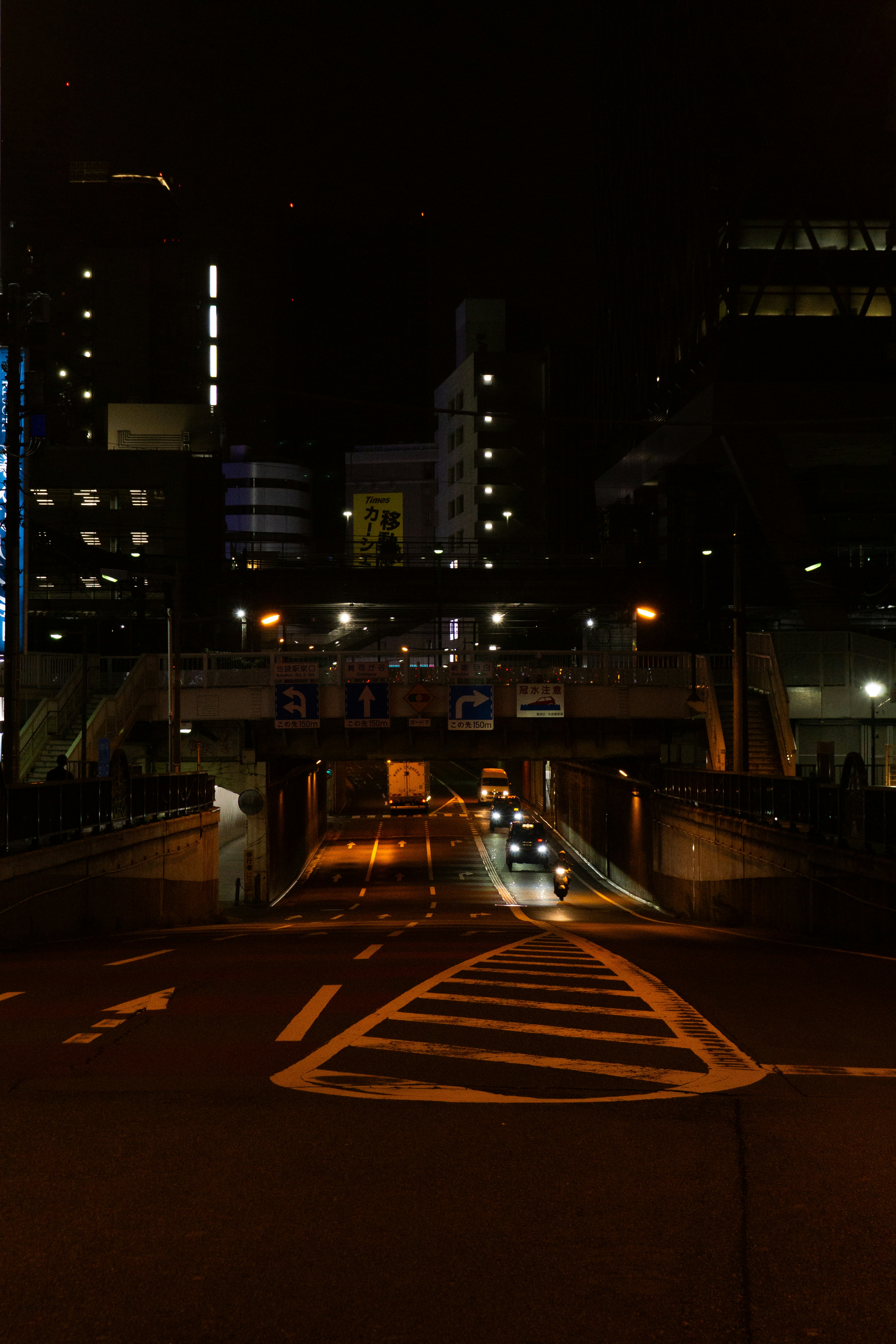 Road into the Neon Night: Cars and Overpass Under Warm Streetlights