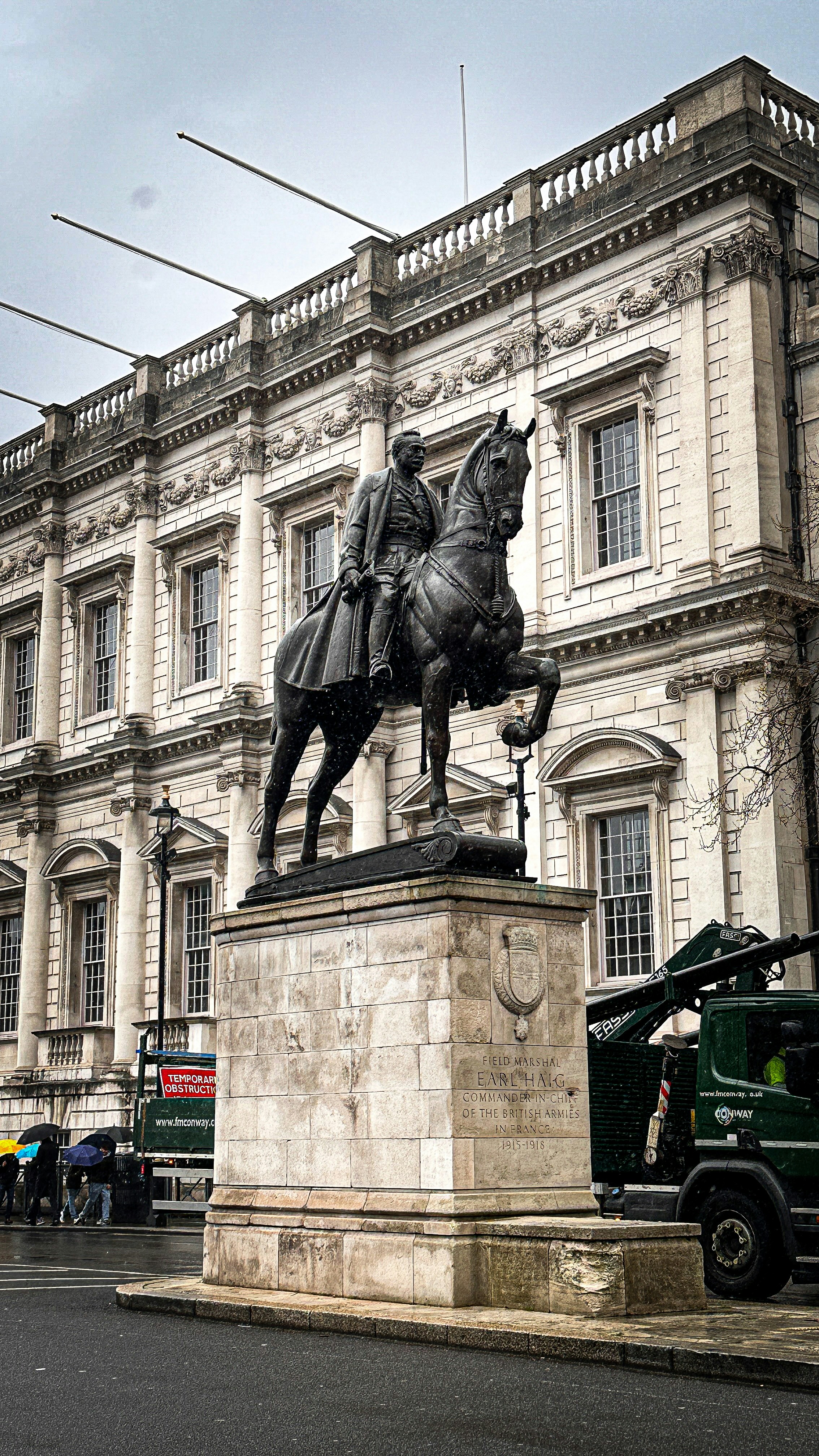 Equestrian Reverence: A Monument Framed by Historic Facade