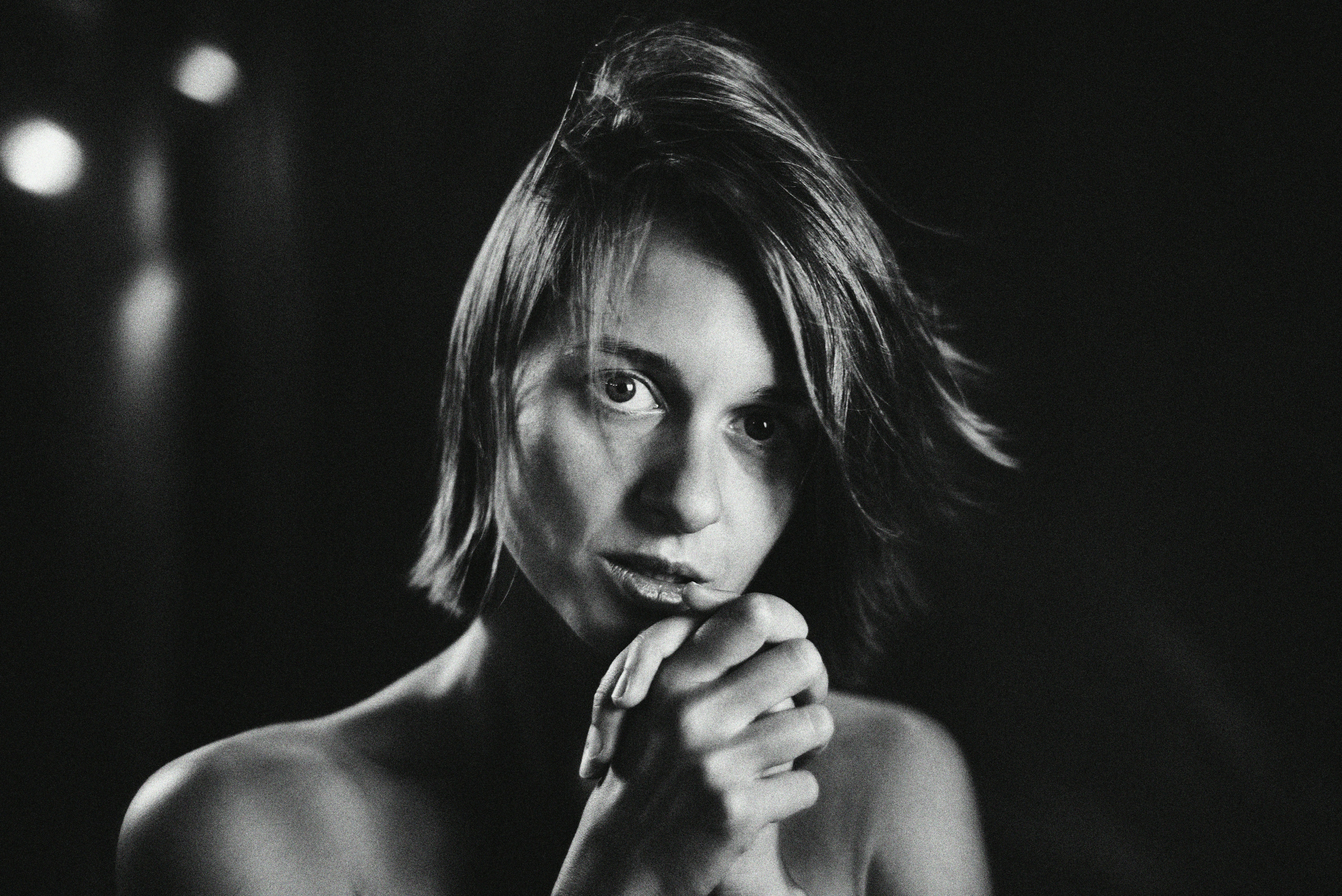 Shadowed Gaze: A Portrait in Monochrome Embrace