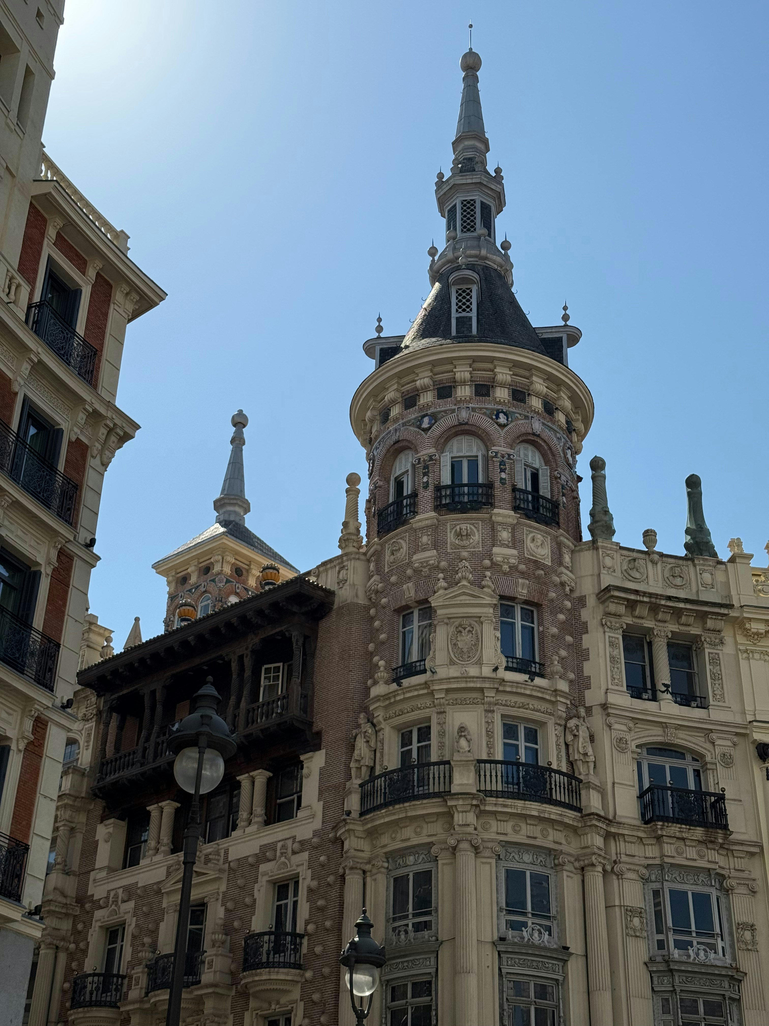 Towering Facade: A Historic Madrid-Style Corner in the Sun