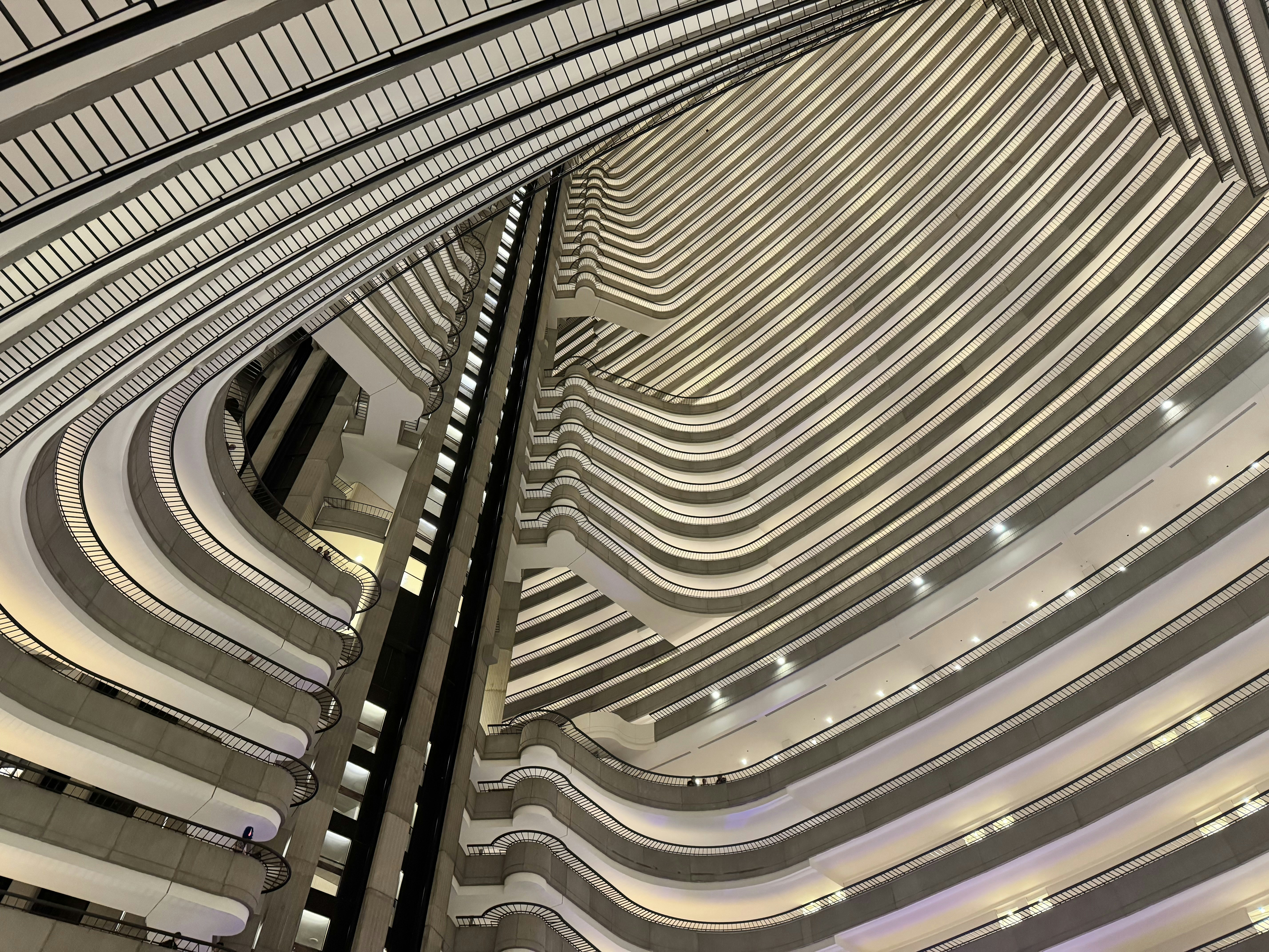 Vertical Echo: Canted Atrium Ribbons Reach Toward the Sky