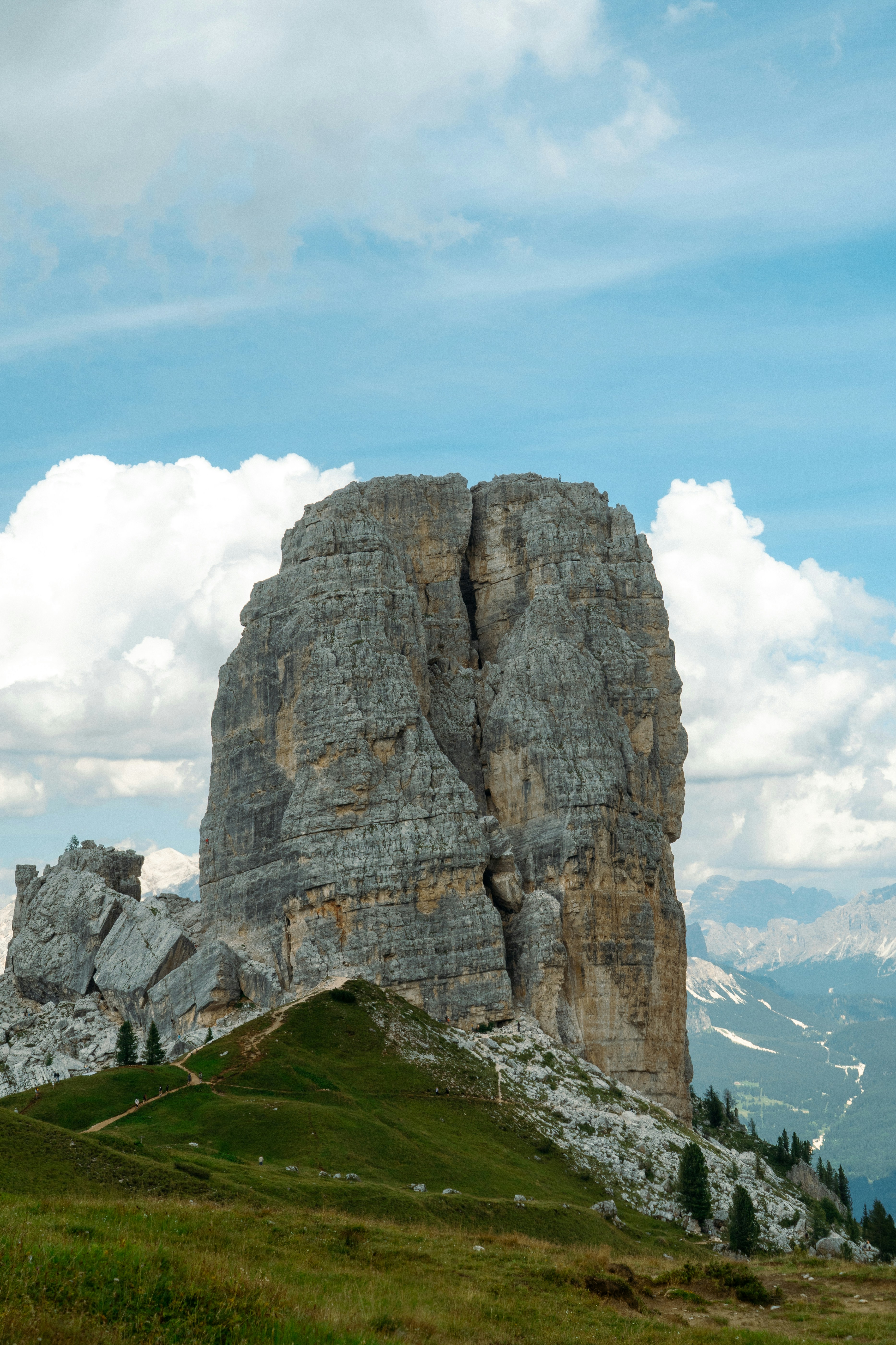 Stone Sentinel Rising Over Alpine Green Slopes