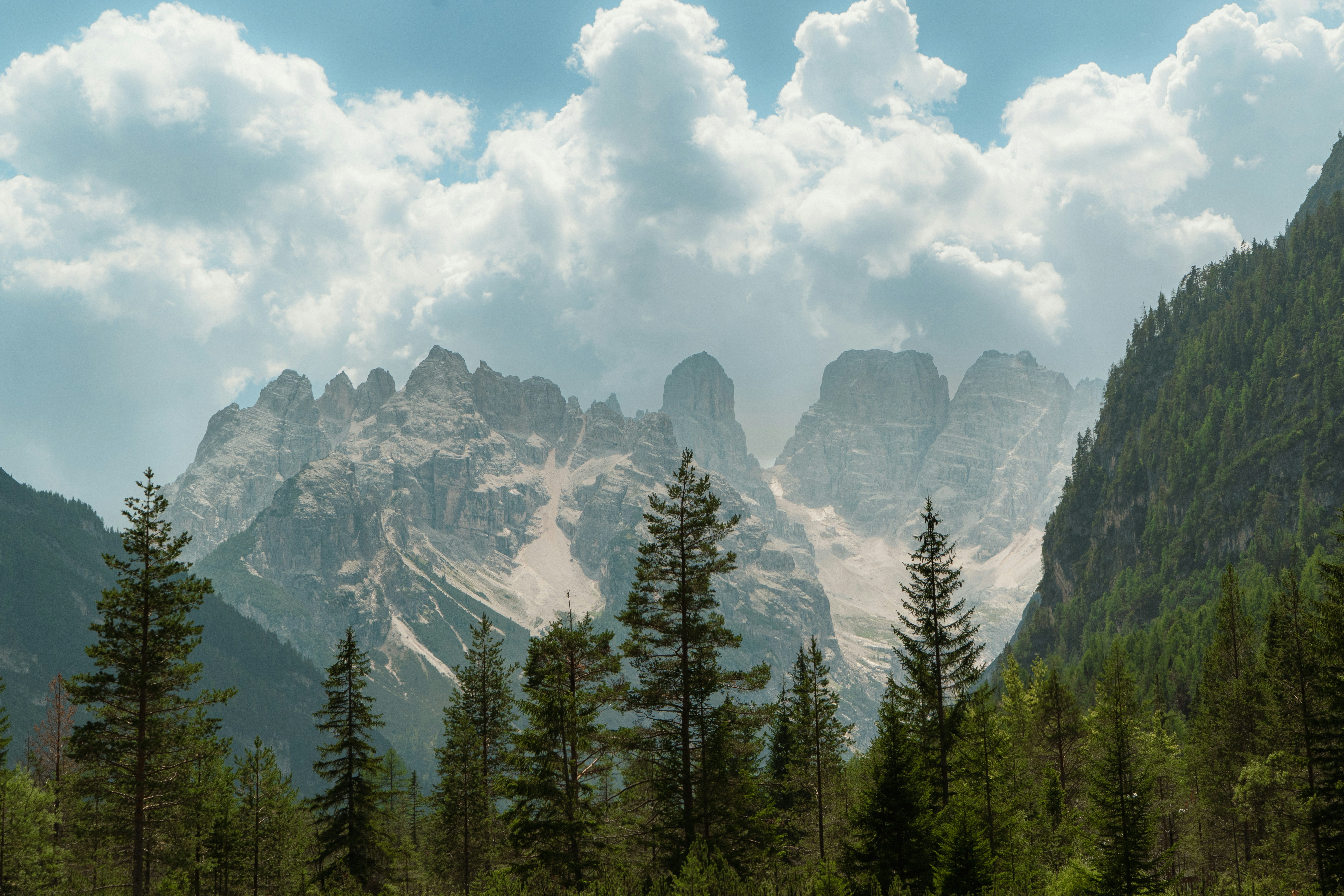 Emerald Peaks Under a Sky of Cotton