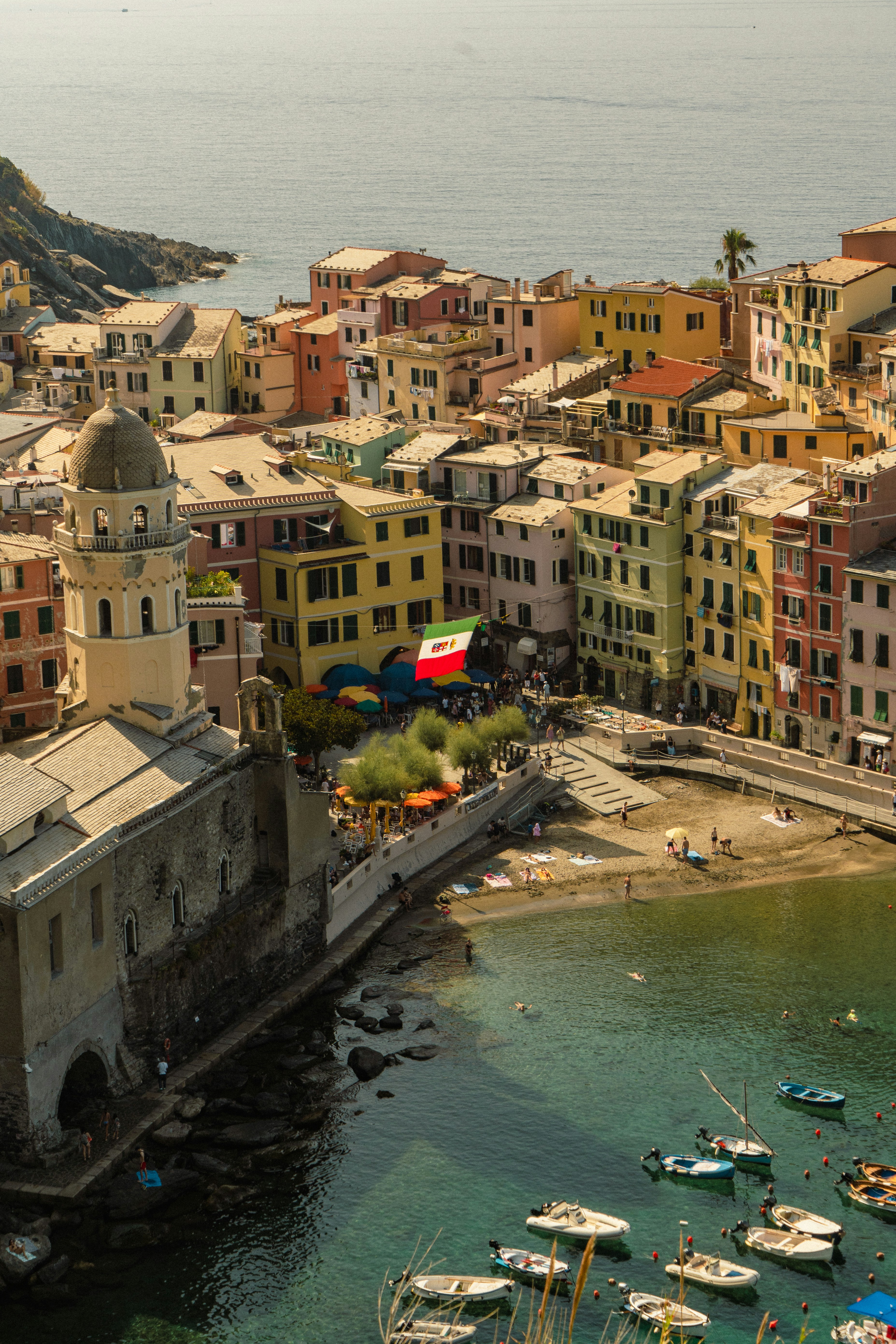 Vibrant waterfront village: pastel houses stack along the sunlit quay