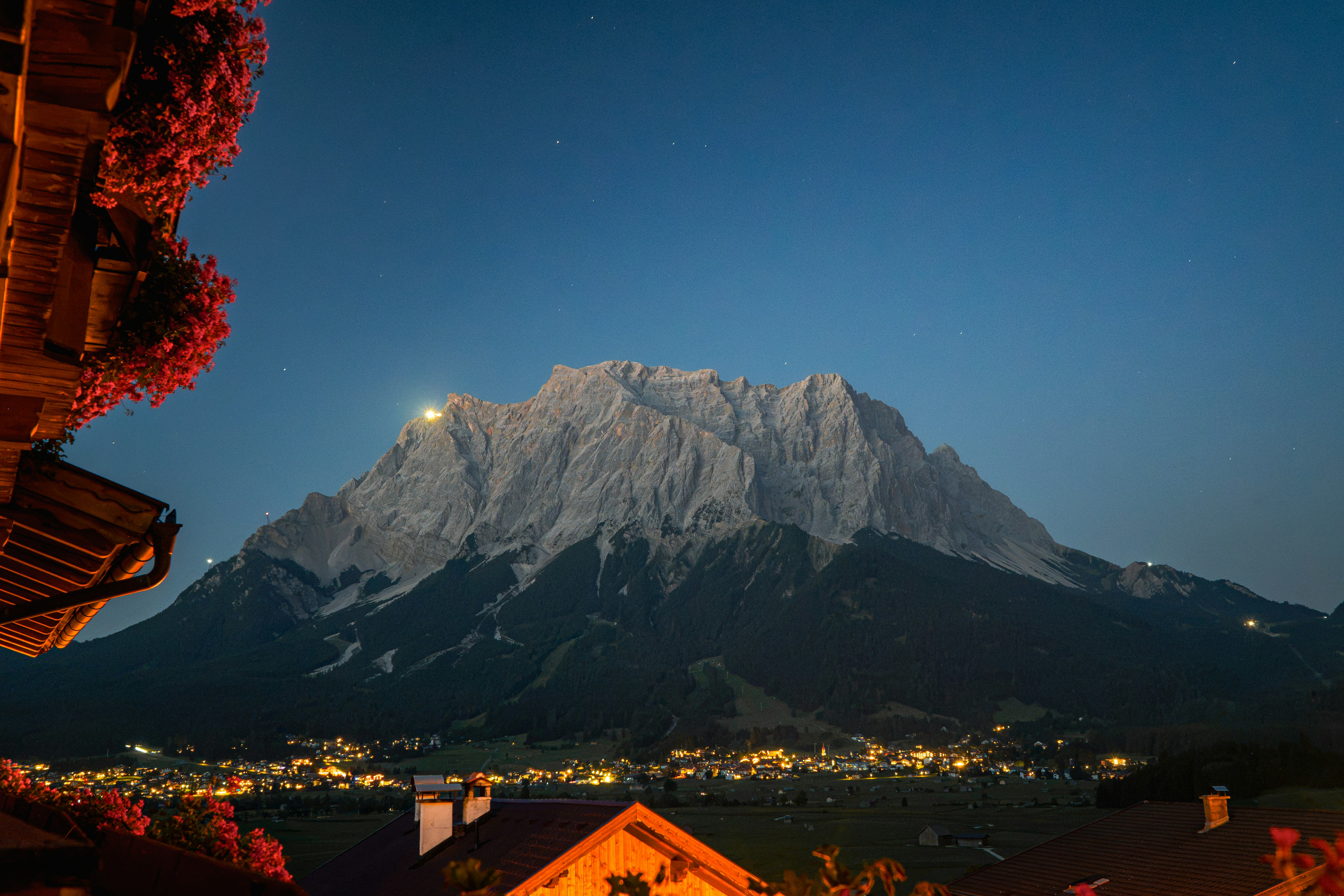 Moonlit Peak Over a Lanterned Alpine Town