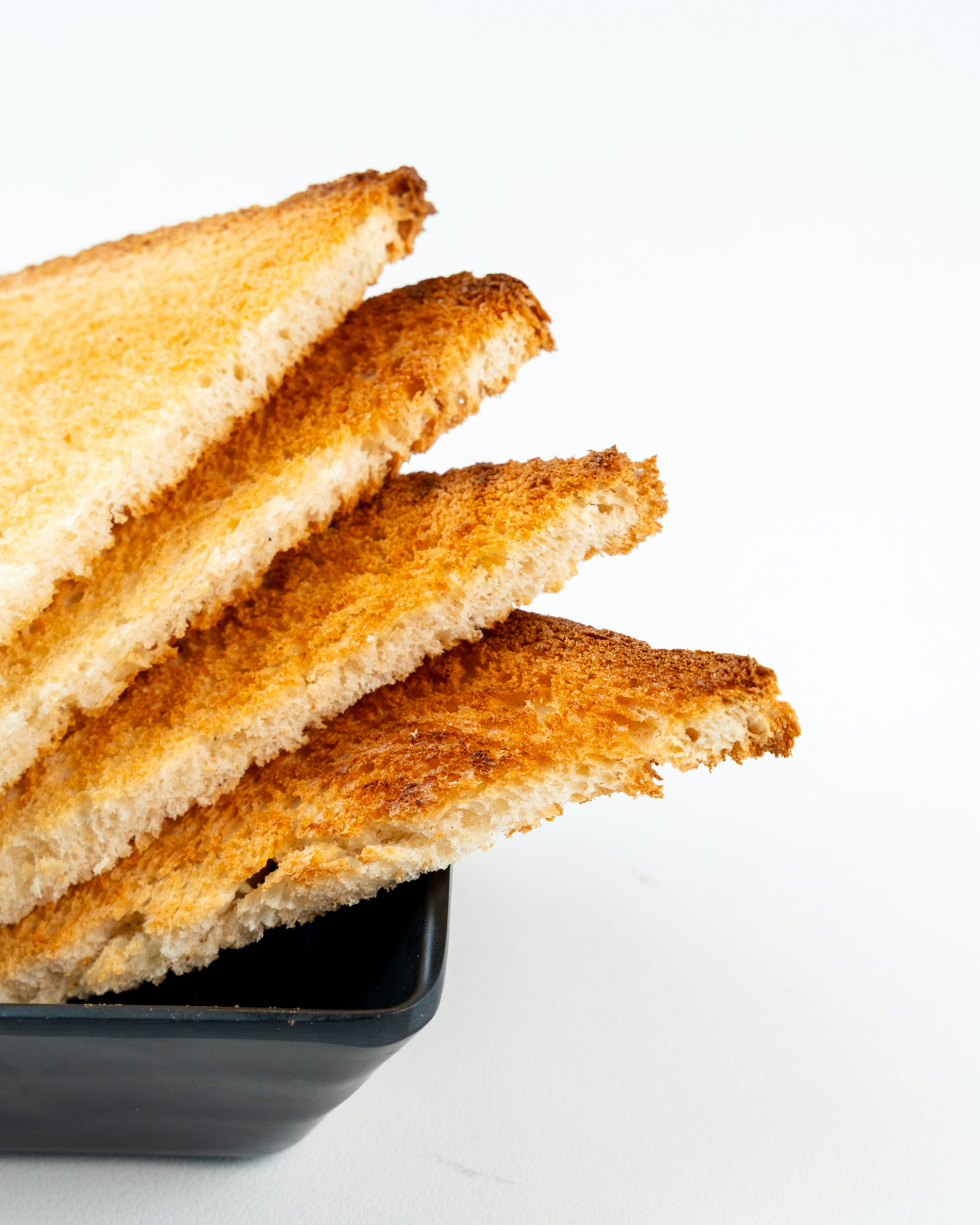Stacked Toasted Slices in a Minimalist White Studio