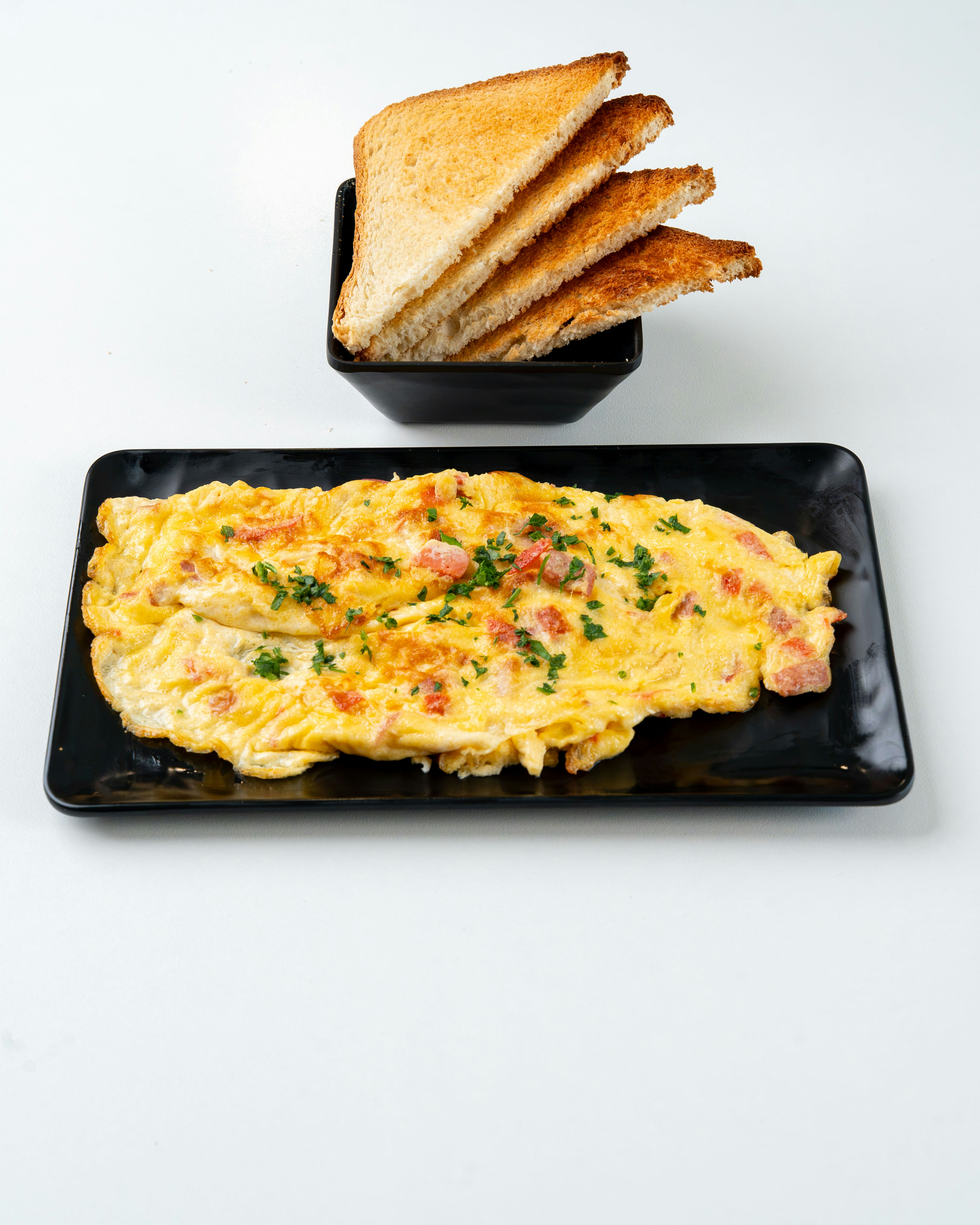 Savory sunrise: scrambled gems on a glossy slate with toasted triangles