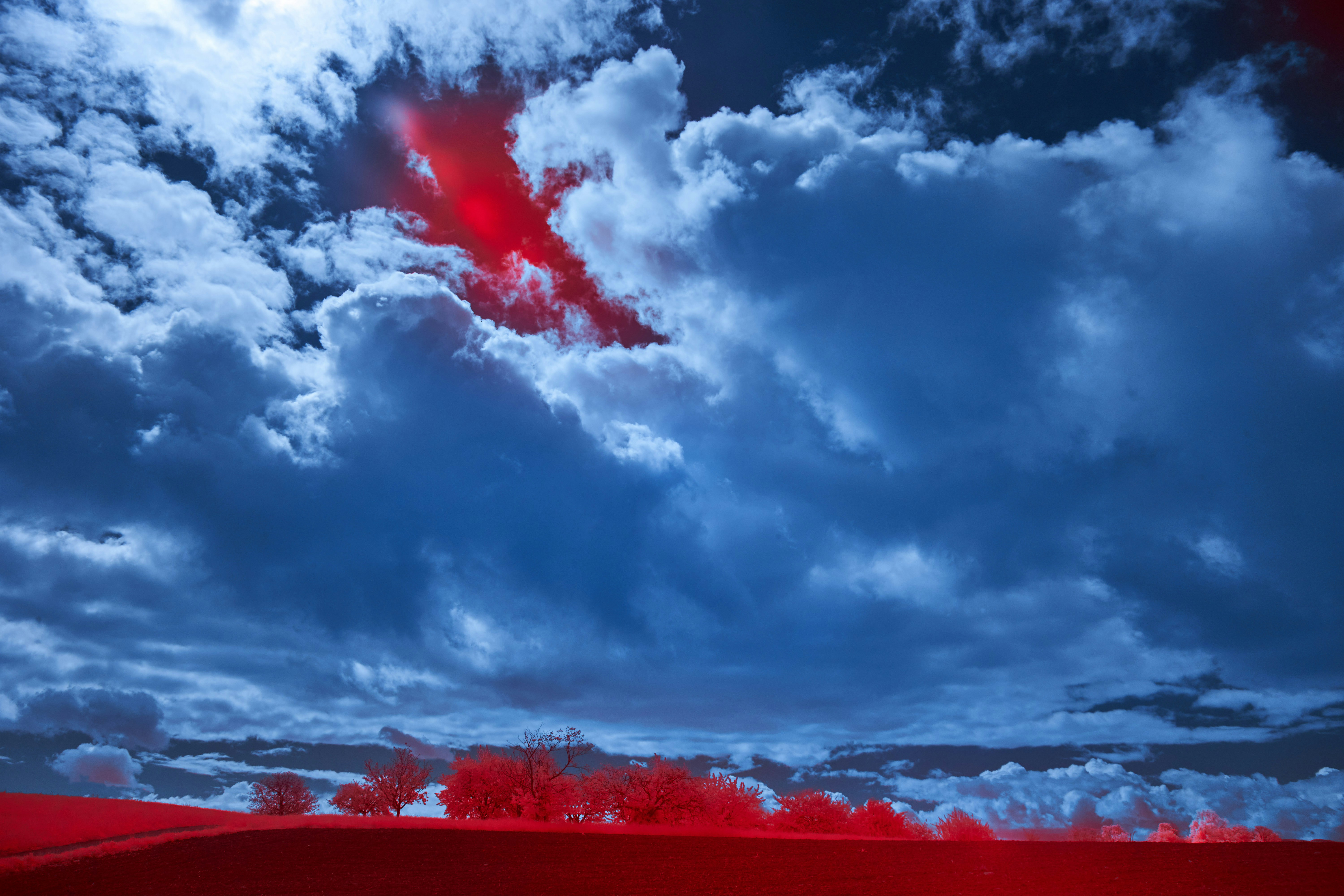 Red Horizon: Low-Lying Terrain Under a Turbulent Sky