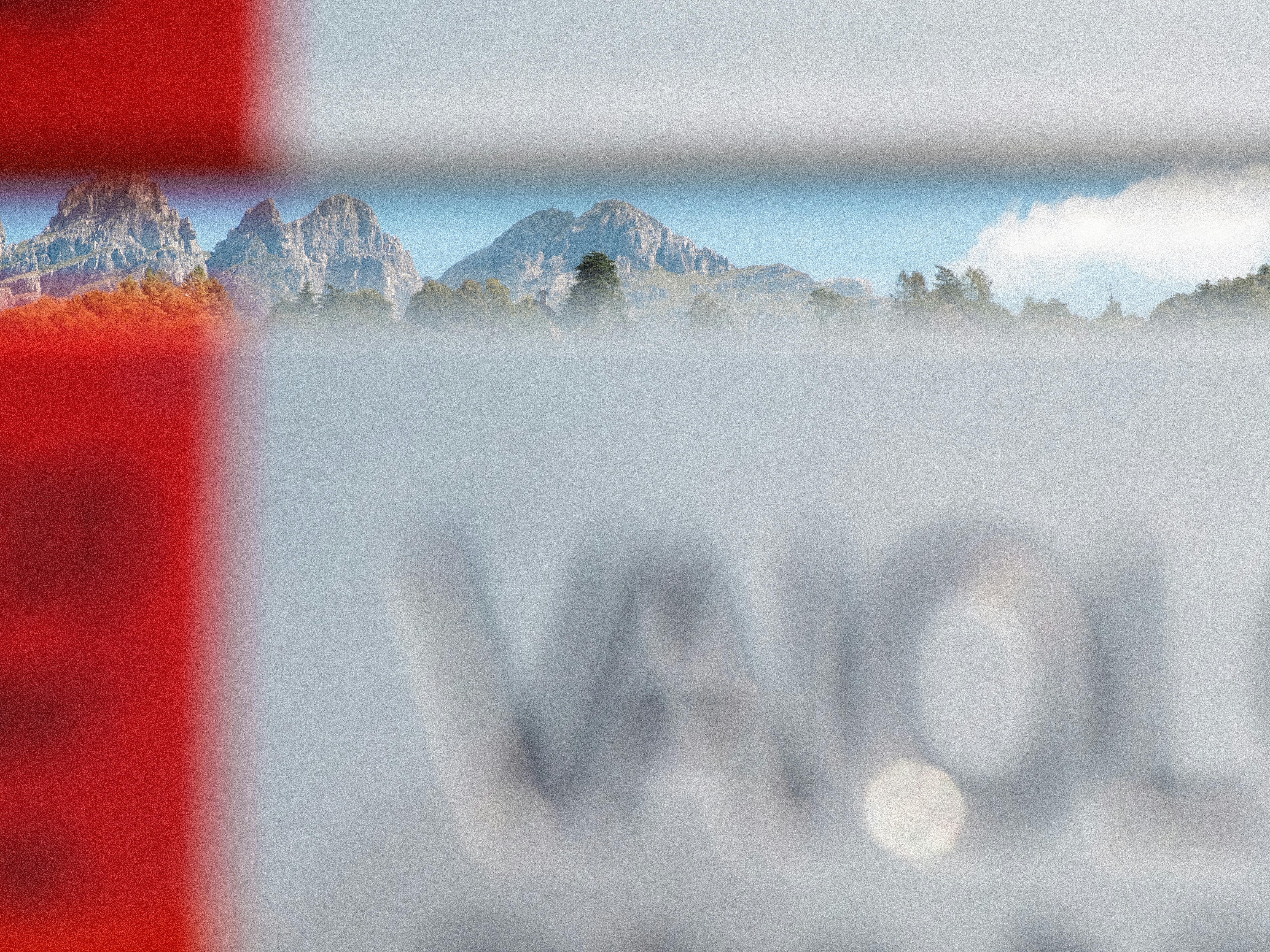 Mist over the Alpine Ridge Framed by Red Glass