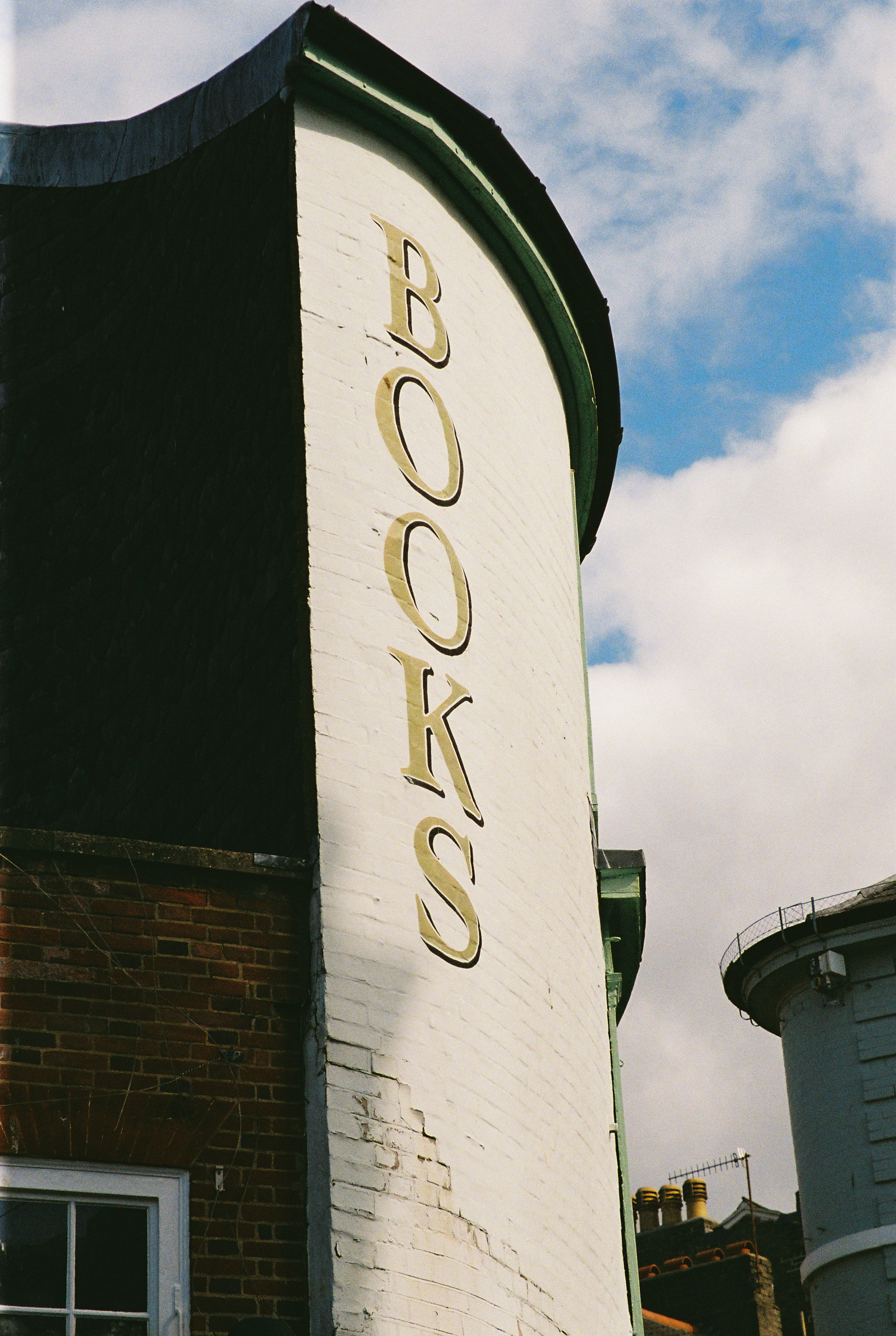 Vertical Signage on a Brick Building Stretches Upward