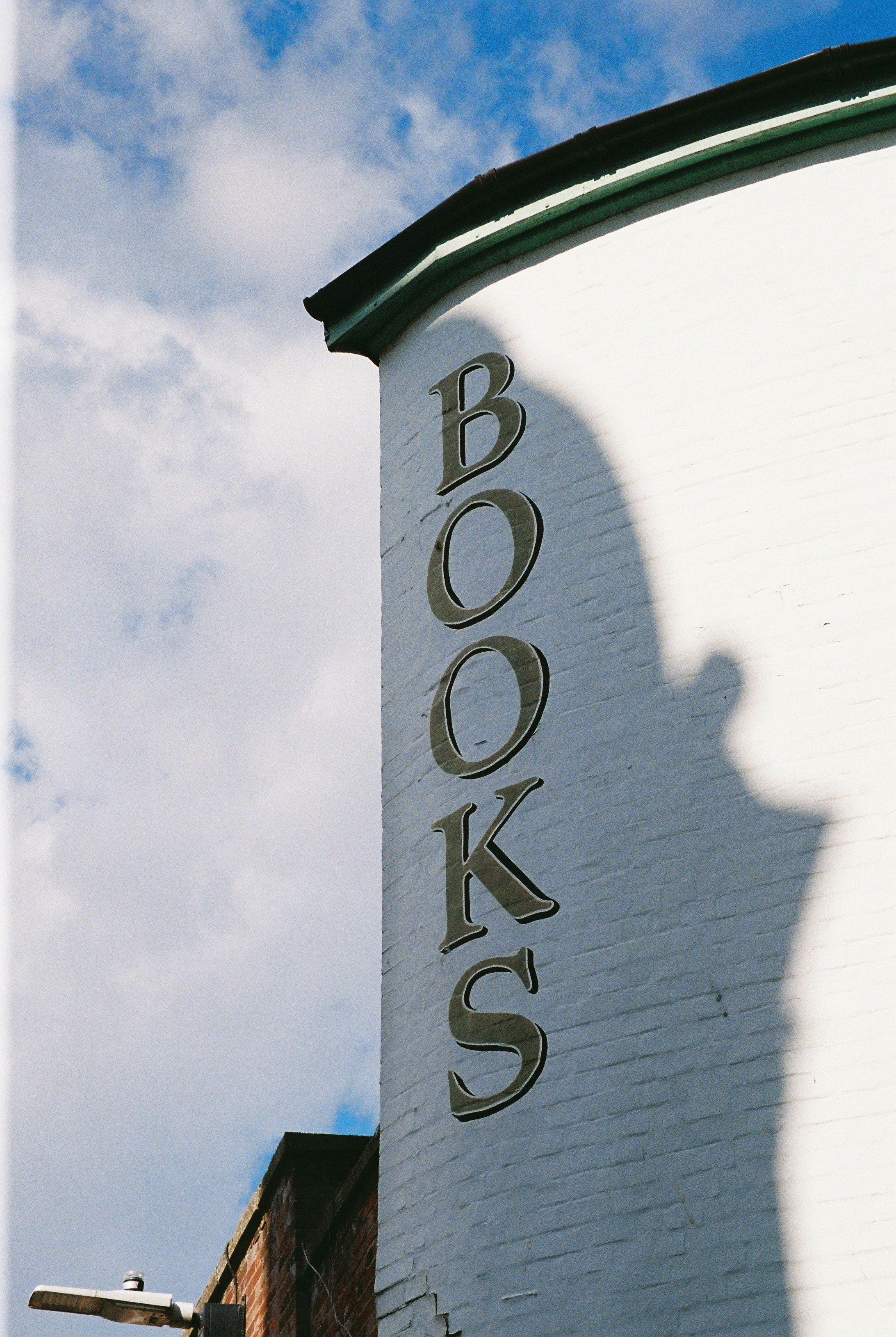 Shadowed Boiler Signage: A Towering Window into a Corner Store