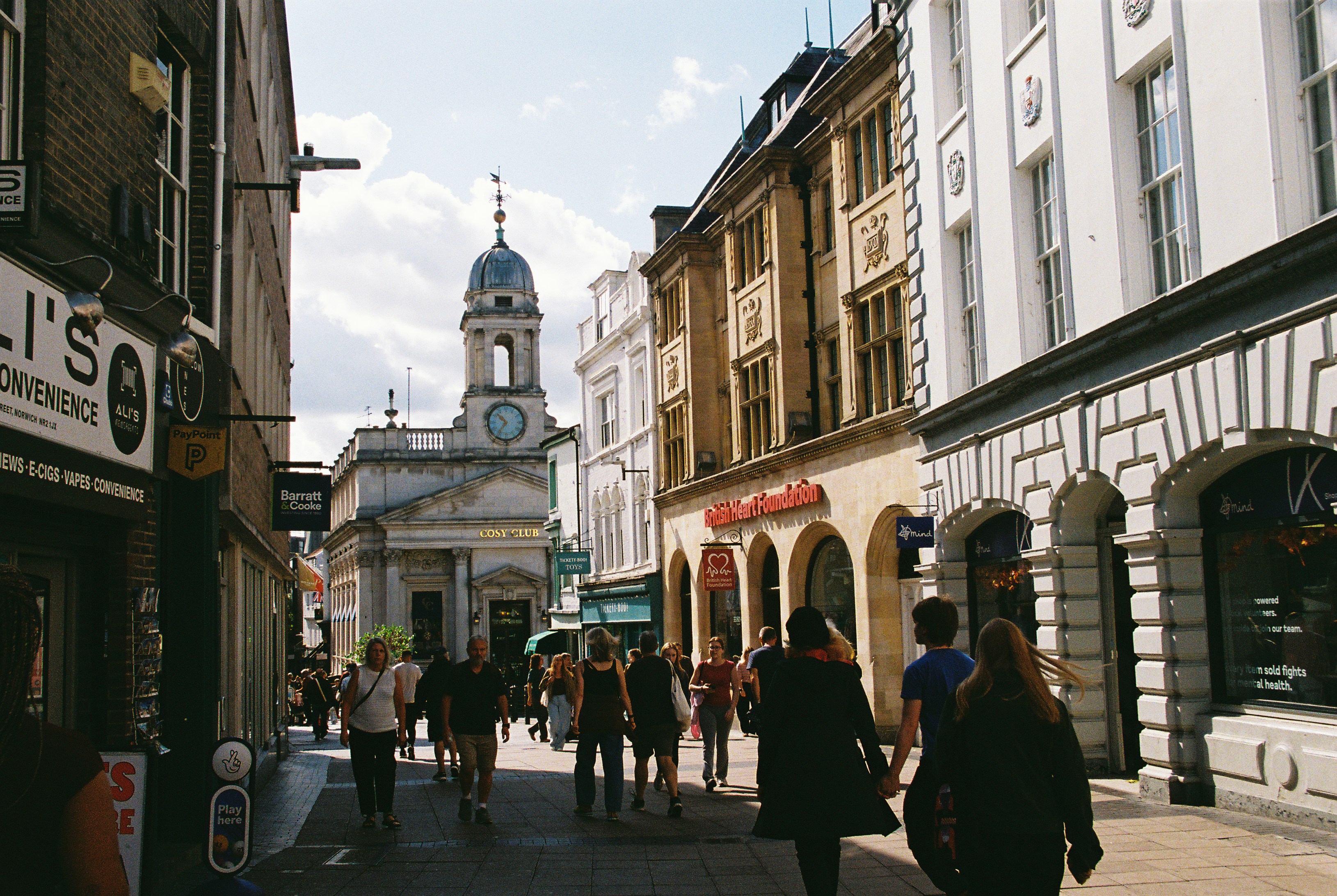 Midstreet Portrait of Movement Beneath a Historic Clock Tower