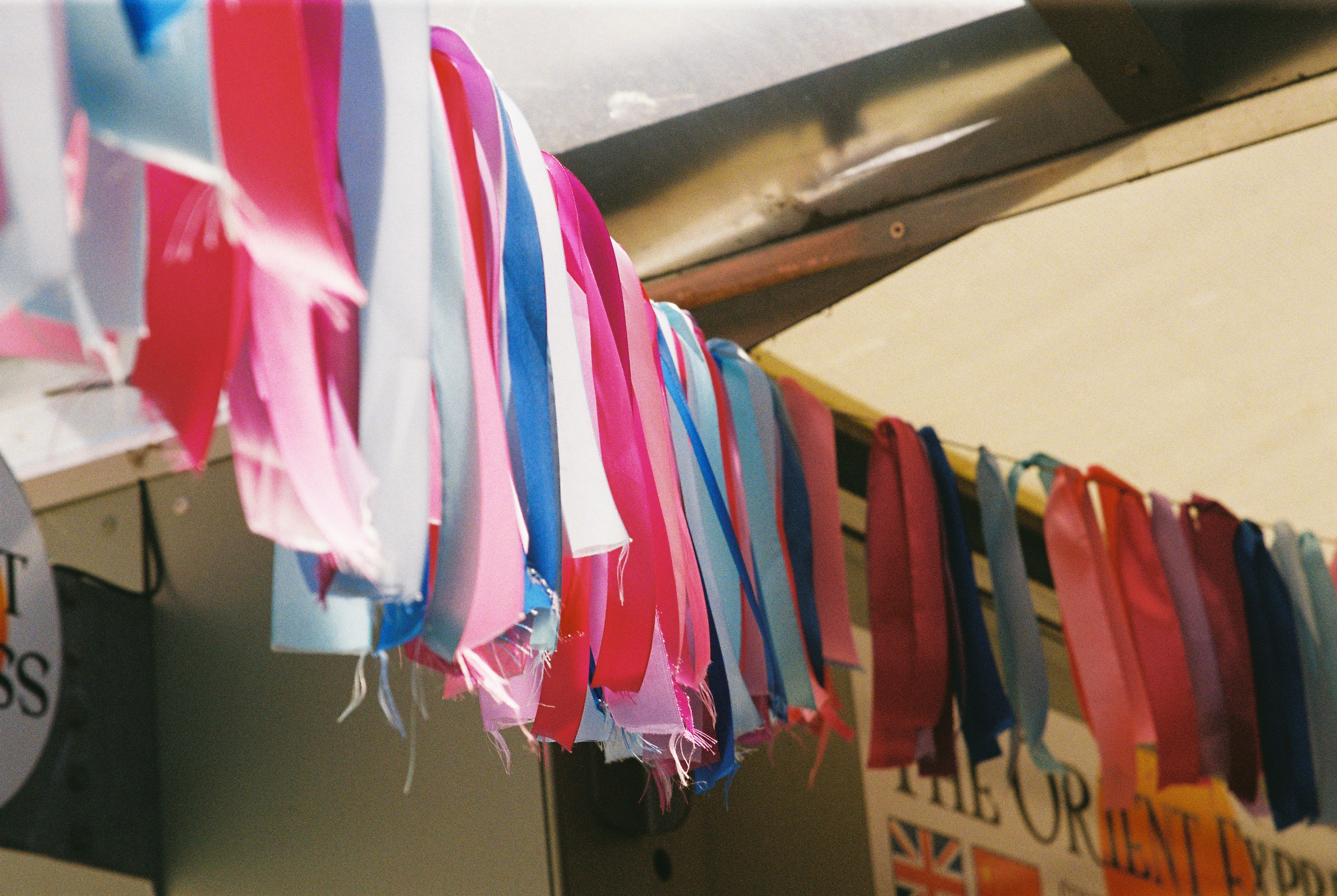 Colorful banners flutter over a market stall edge