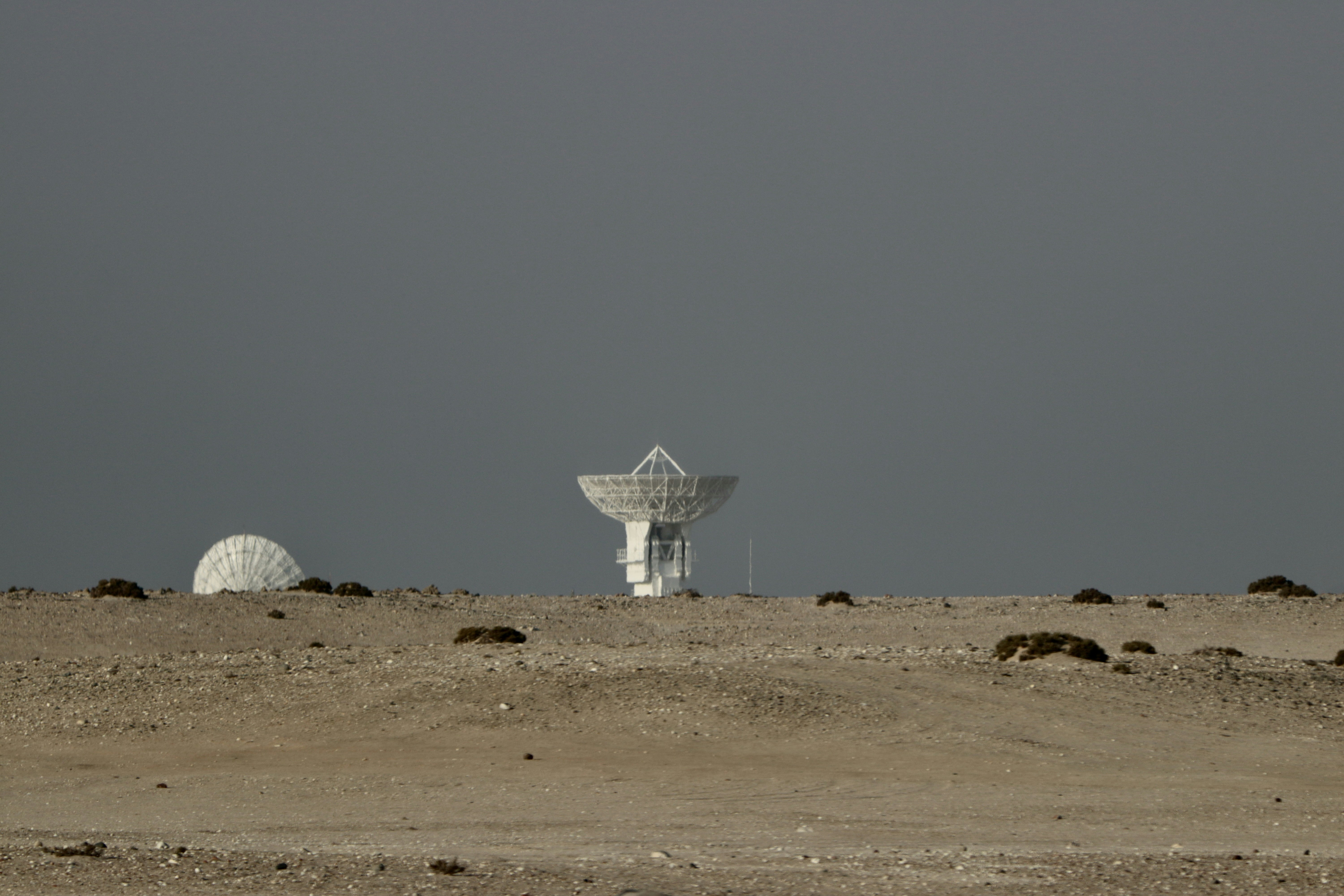 Radar Dome on the Horizon: A Desert Outpost Under Broad Skies