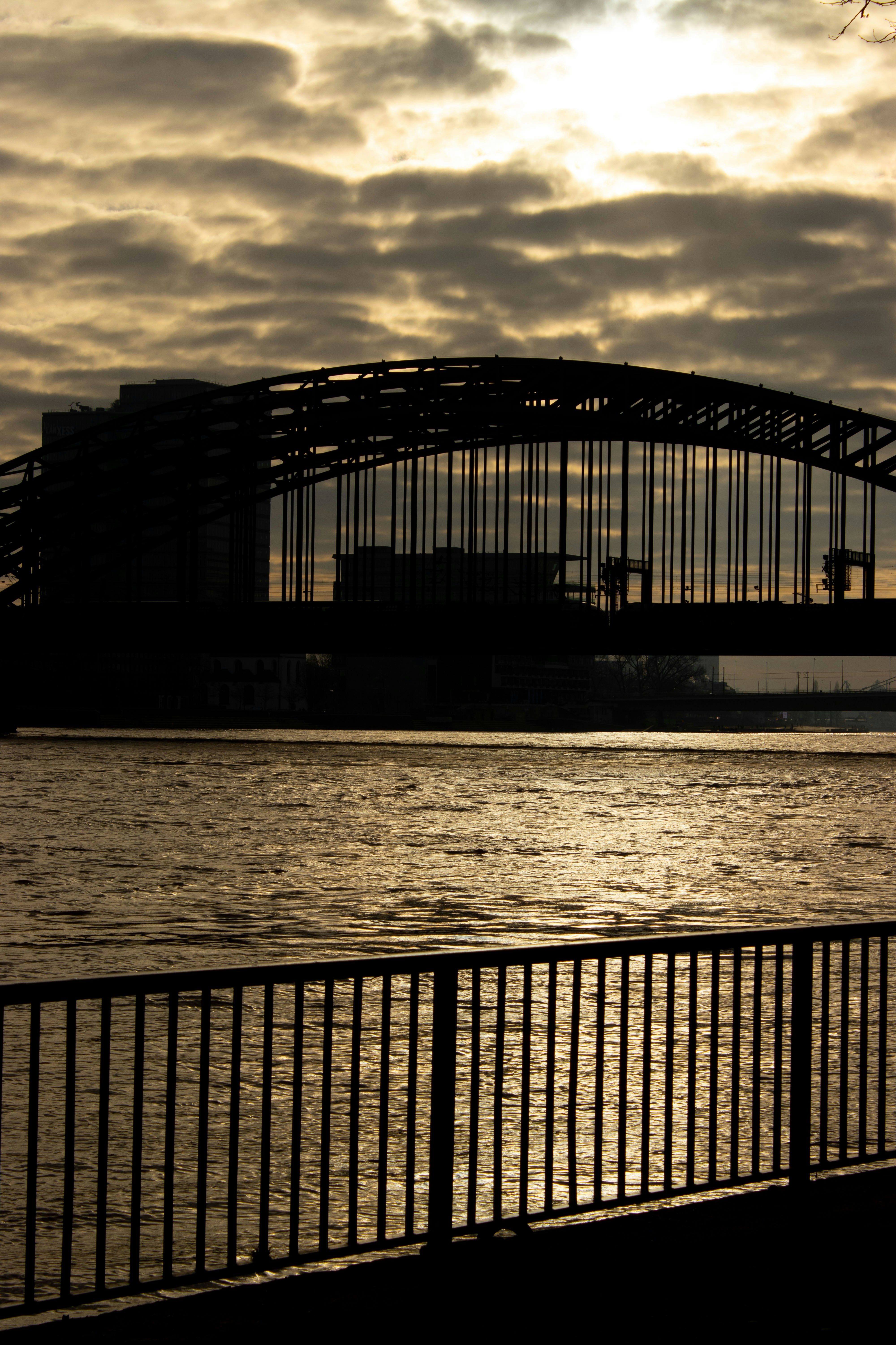 Silhouette Over the River: The Bridge at Sunset