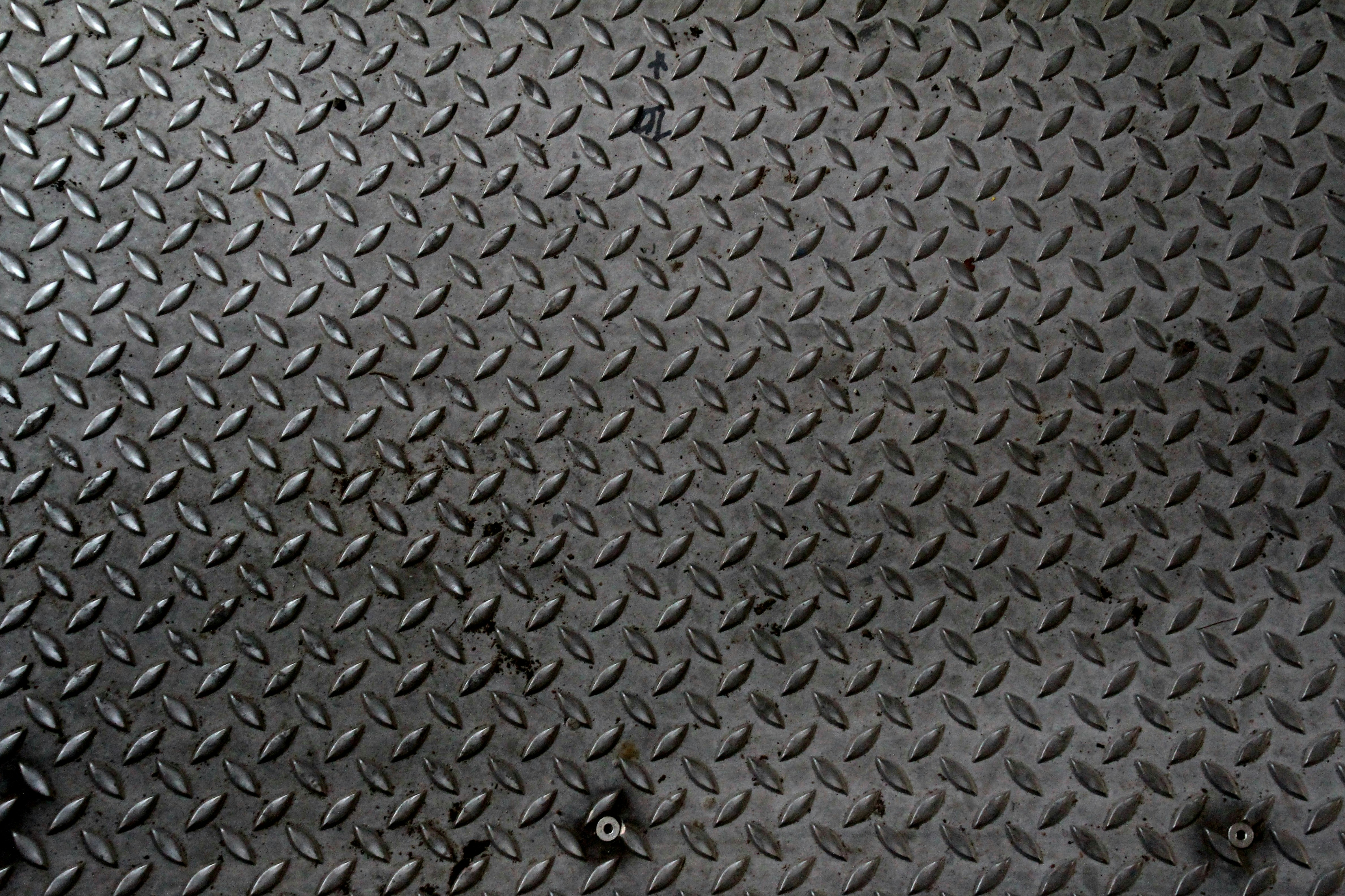Industrial Rhythms: Diamond Plate Texture Under Angular Light
