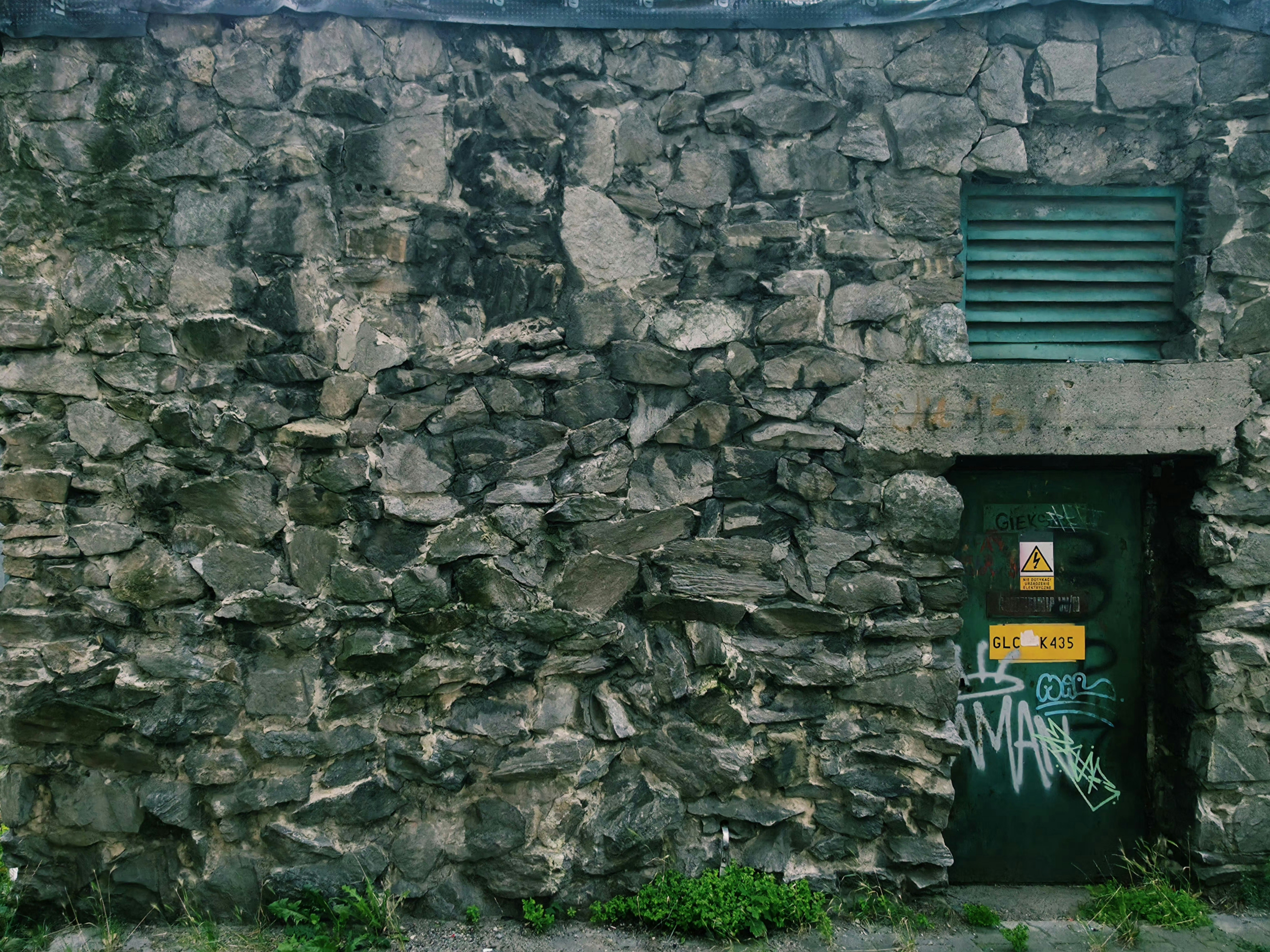 Hidden Gate in a Stony Facade