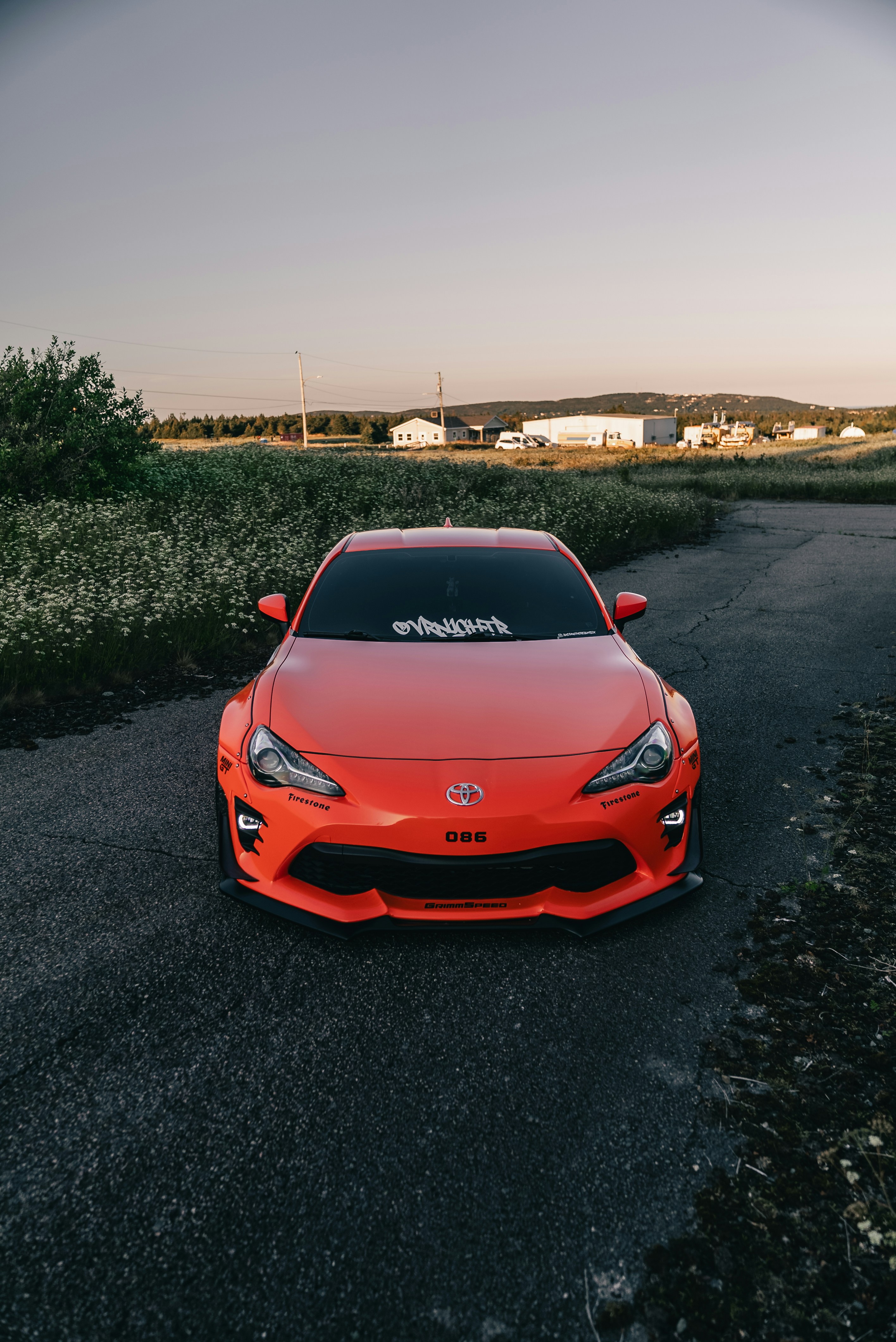 Red Thunder at Dawn: The Front View of a Modified BRZ in a Quiet Field