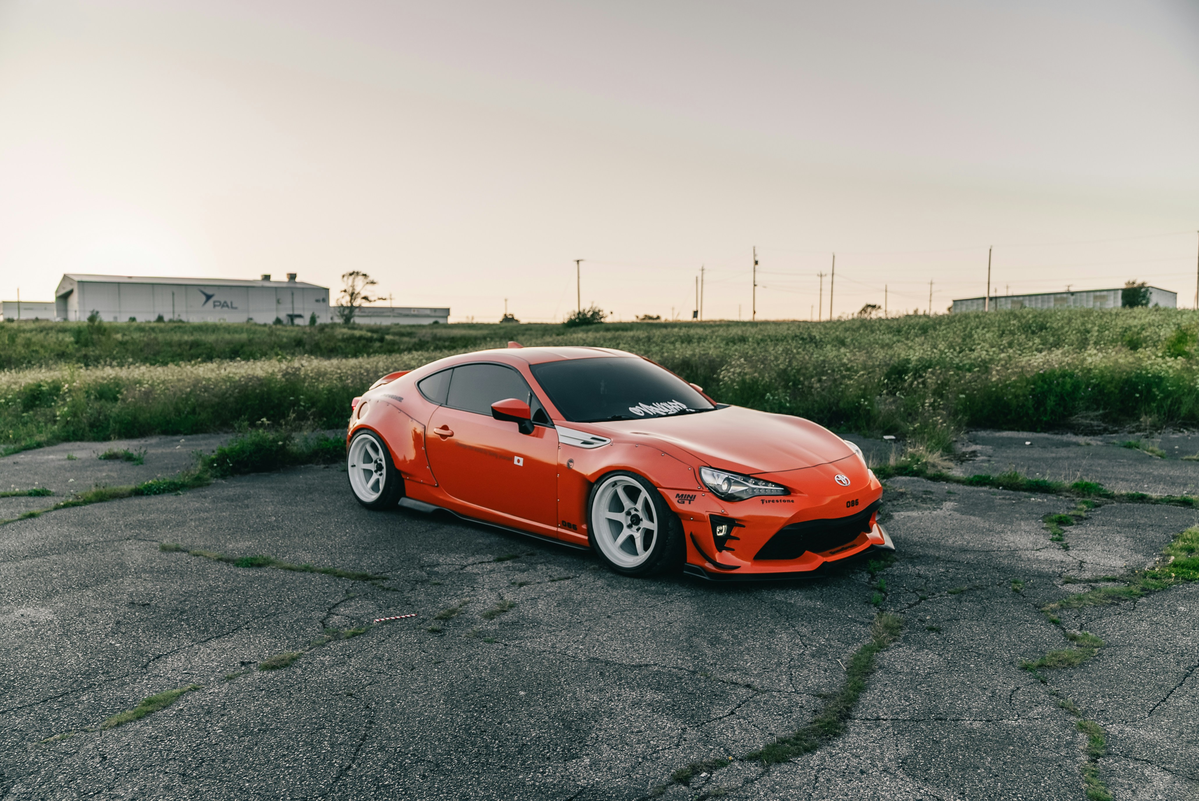 Red Precision: A Low-Slung Car on Weathered Concrete