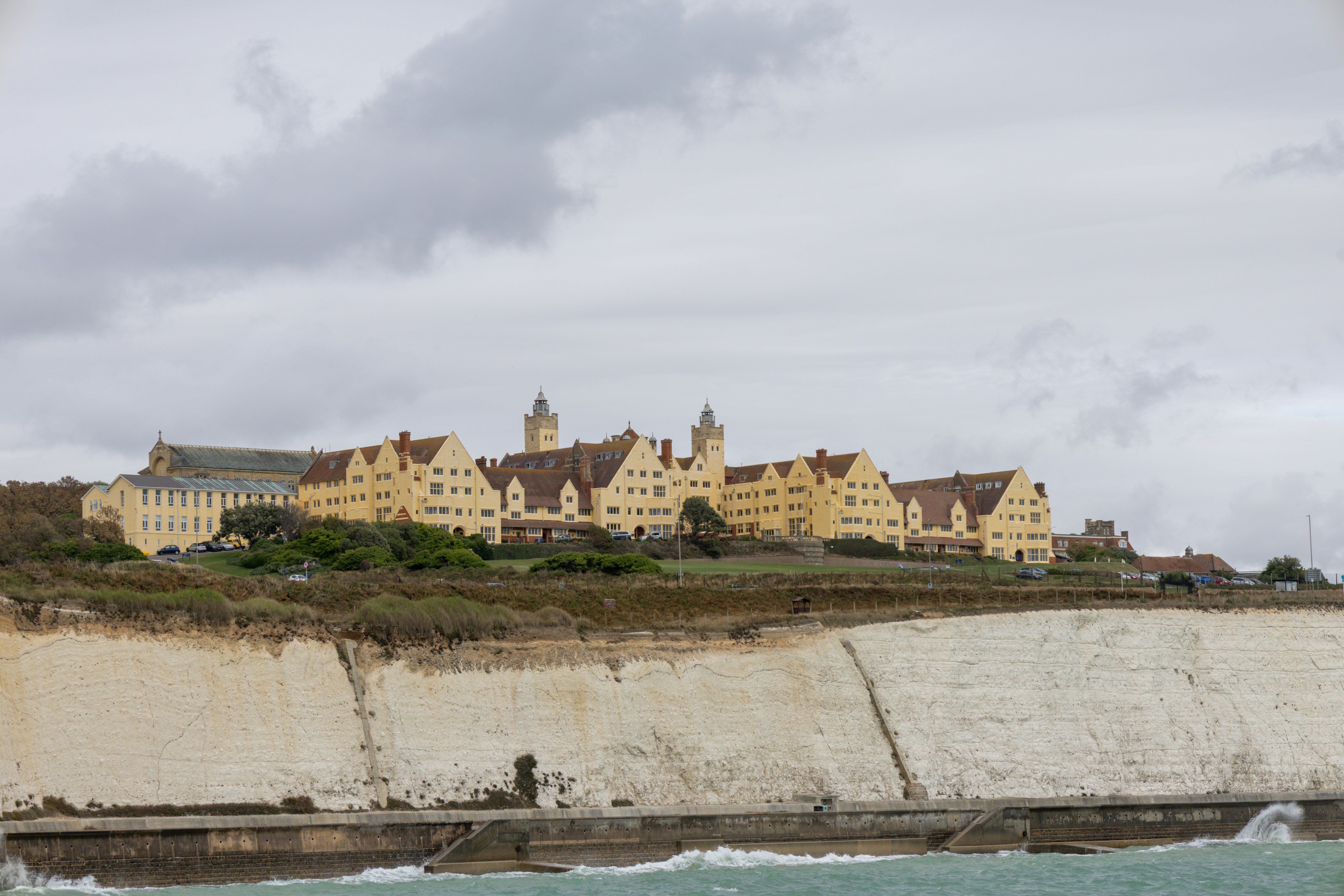 Clifftop village tides under a gray wash