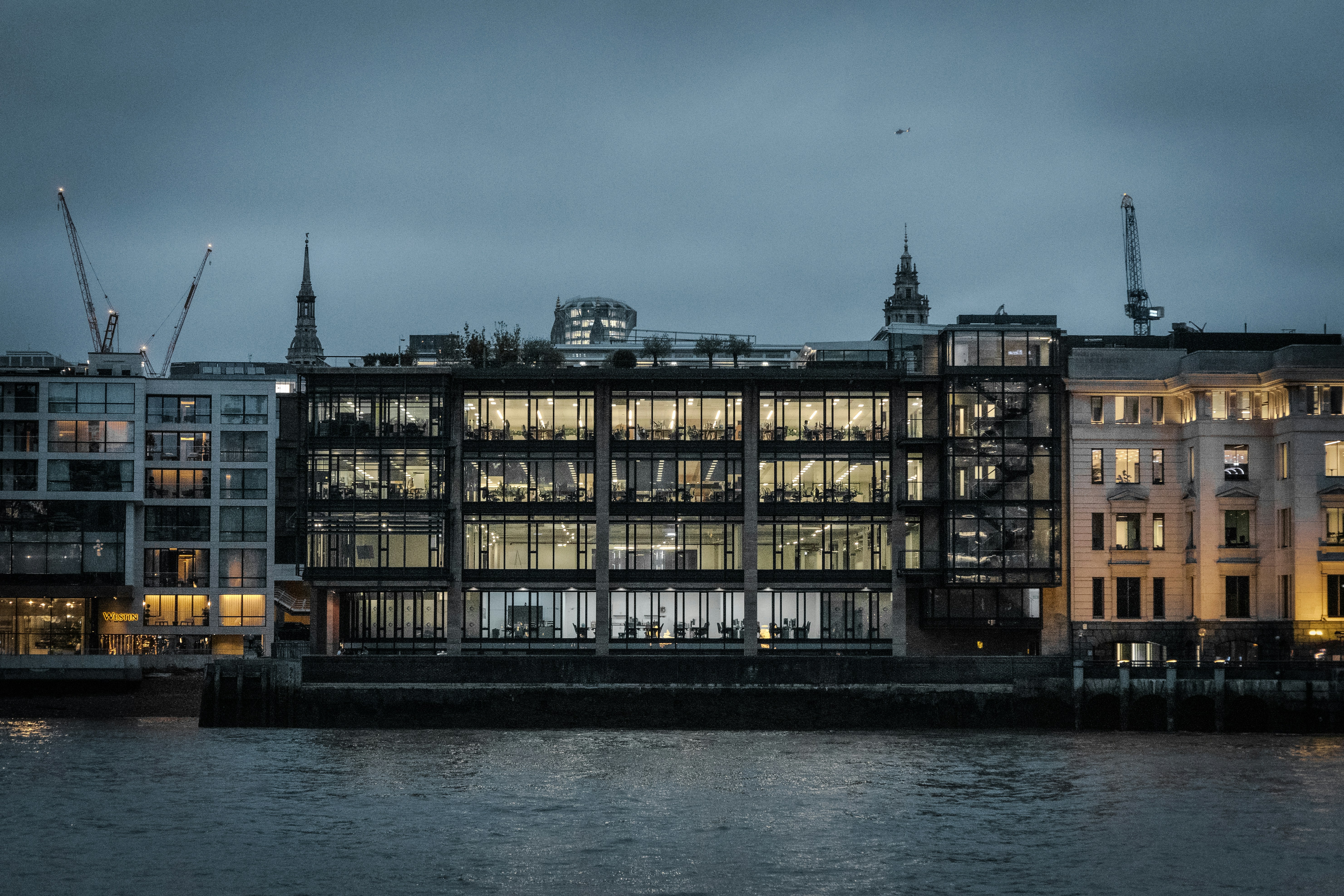 Glass-and-Brick Riverside: Modern Office Faces the Thames at Dusk