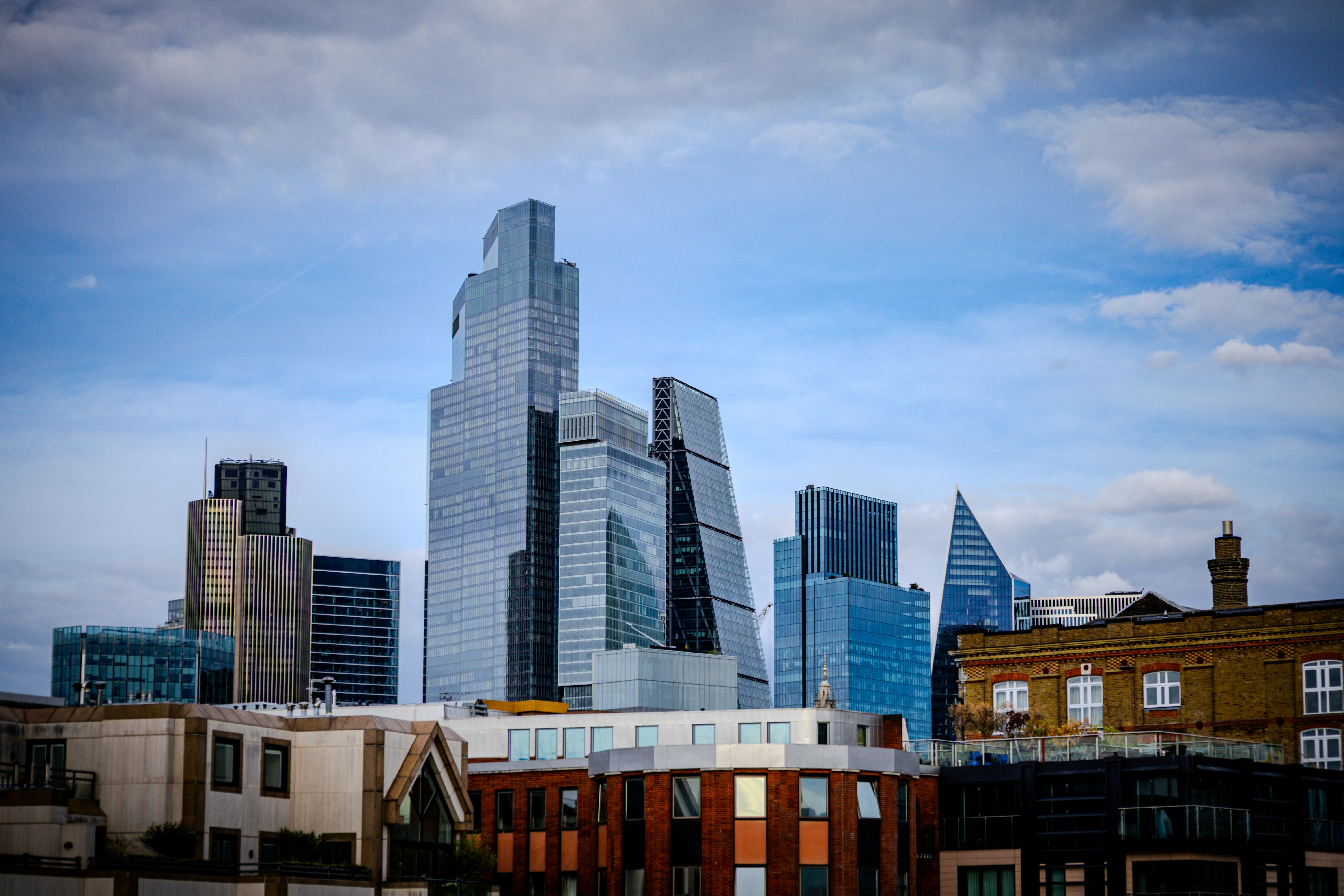 Skyline Crown: Modern Towers Rising Above Humble Rooftops
