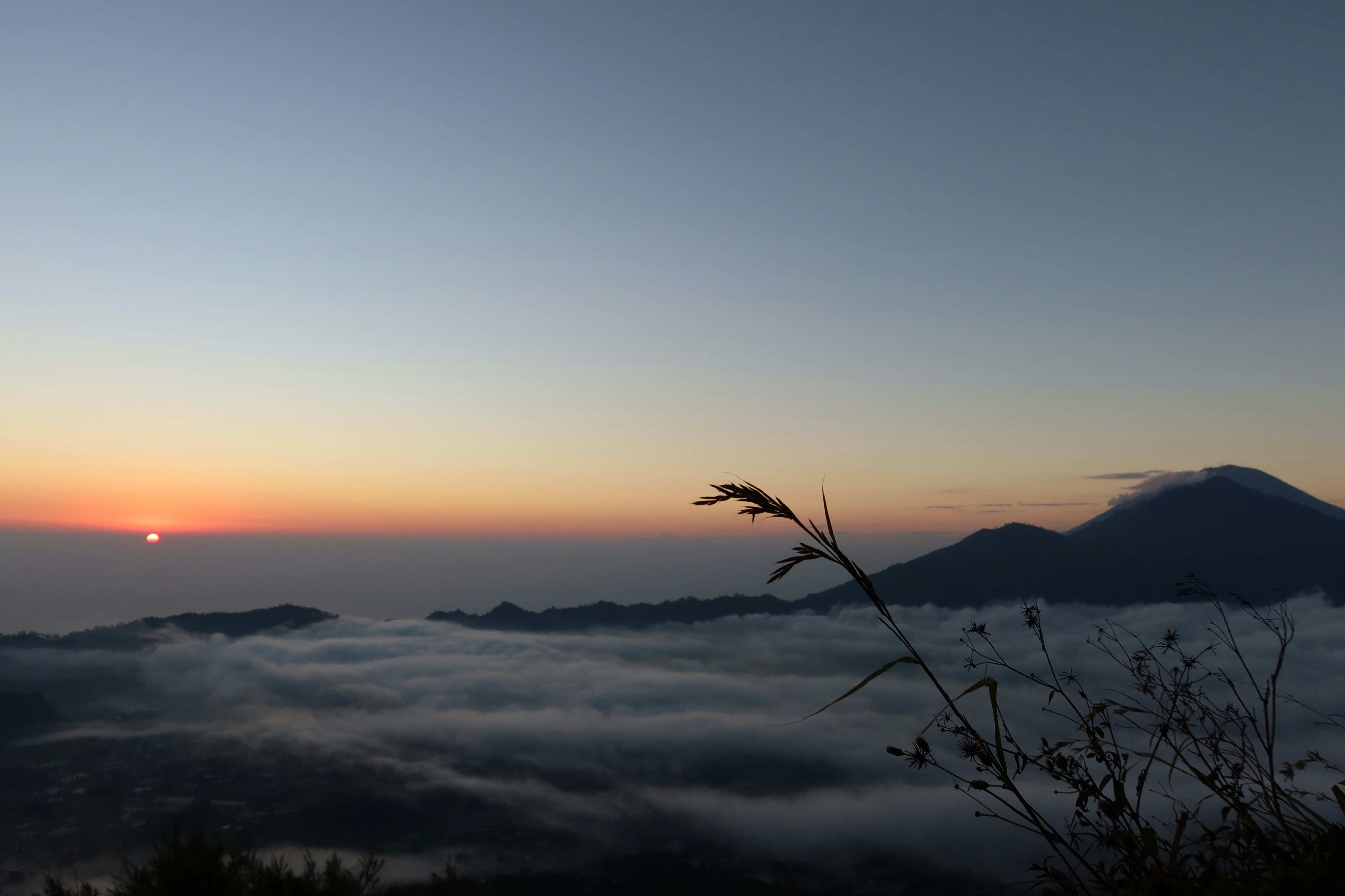 First Light on the Crest: Sunrise over a Sea of Clouds