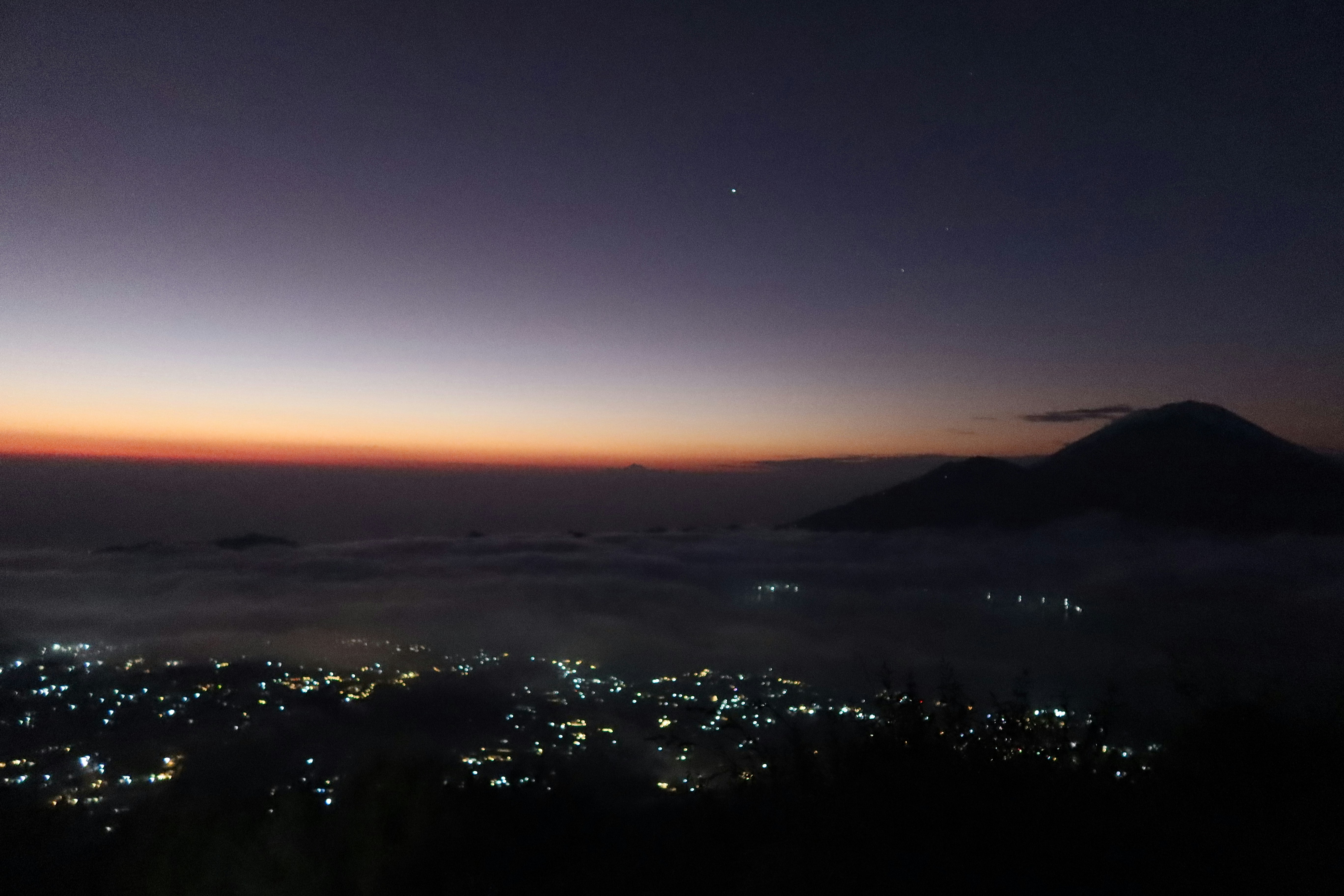 Dawn Crest Over a City Veiled in Velvet Clouds