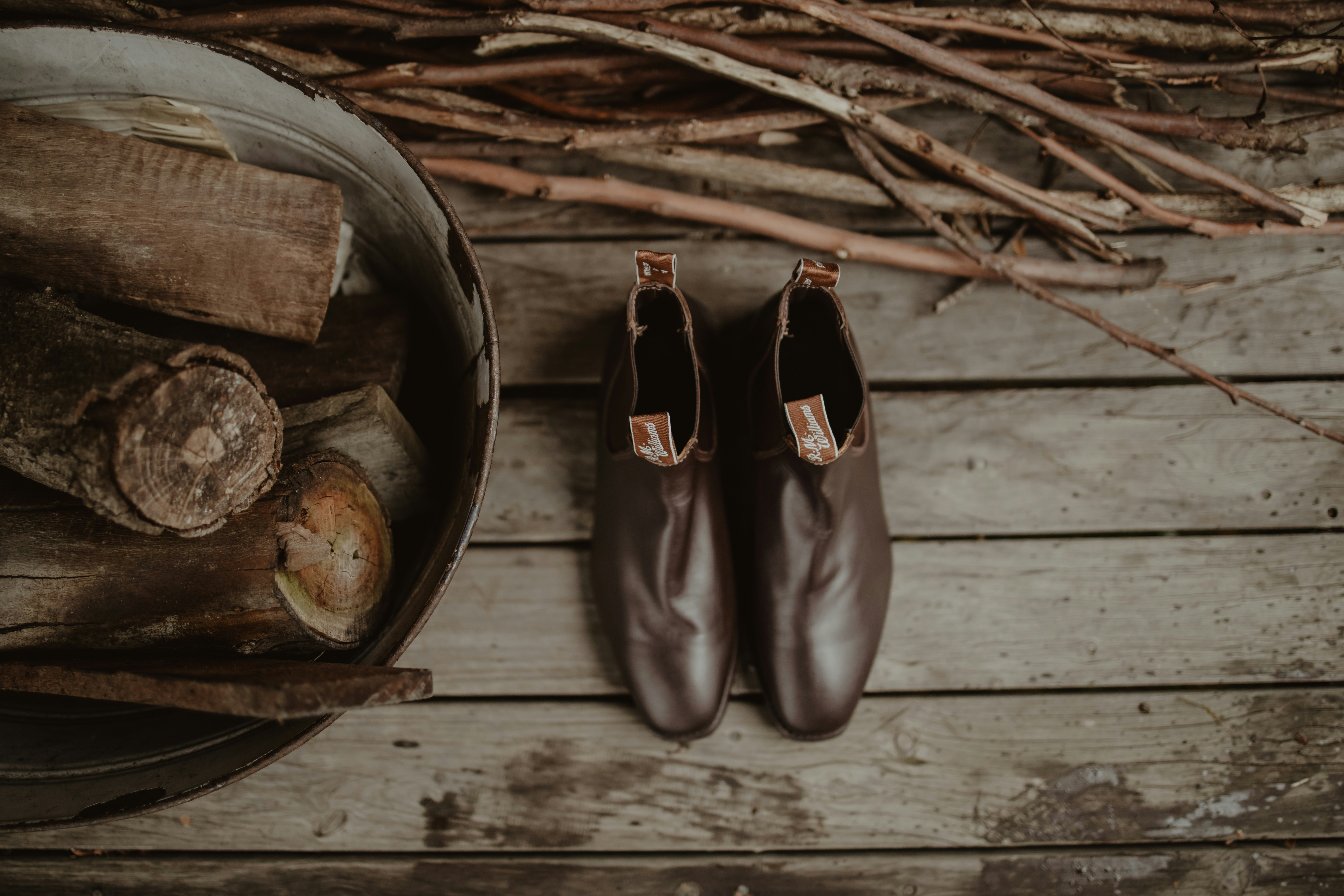 Lone Boots Await by the Woodpile