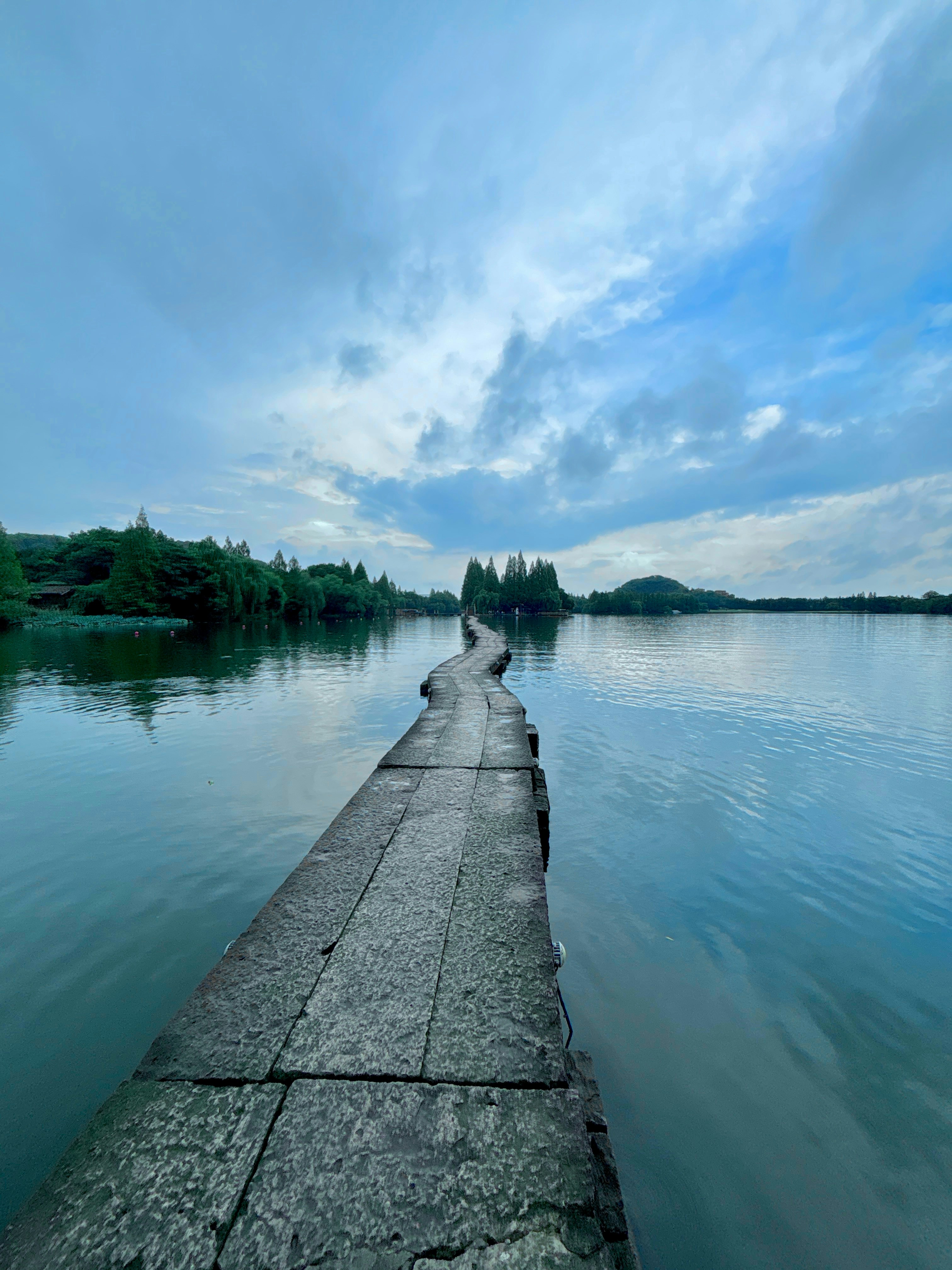 A Stone Causeway Reaching Across a Serene Lake