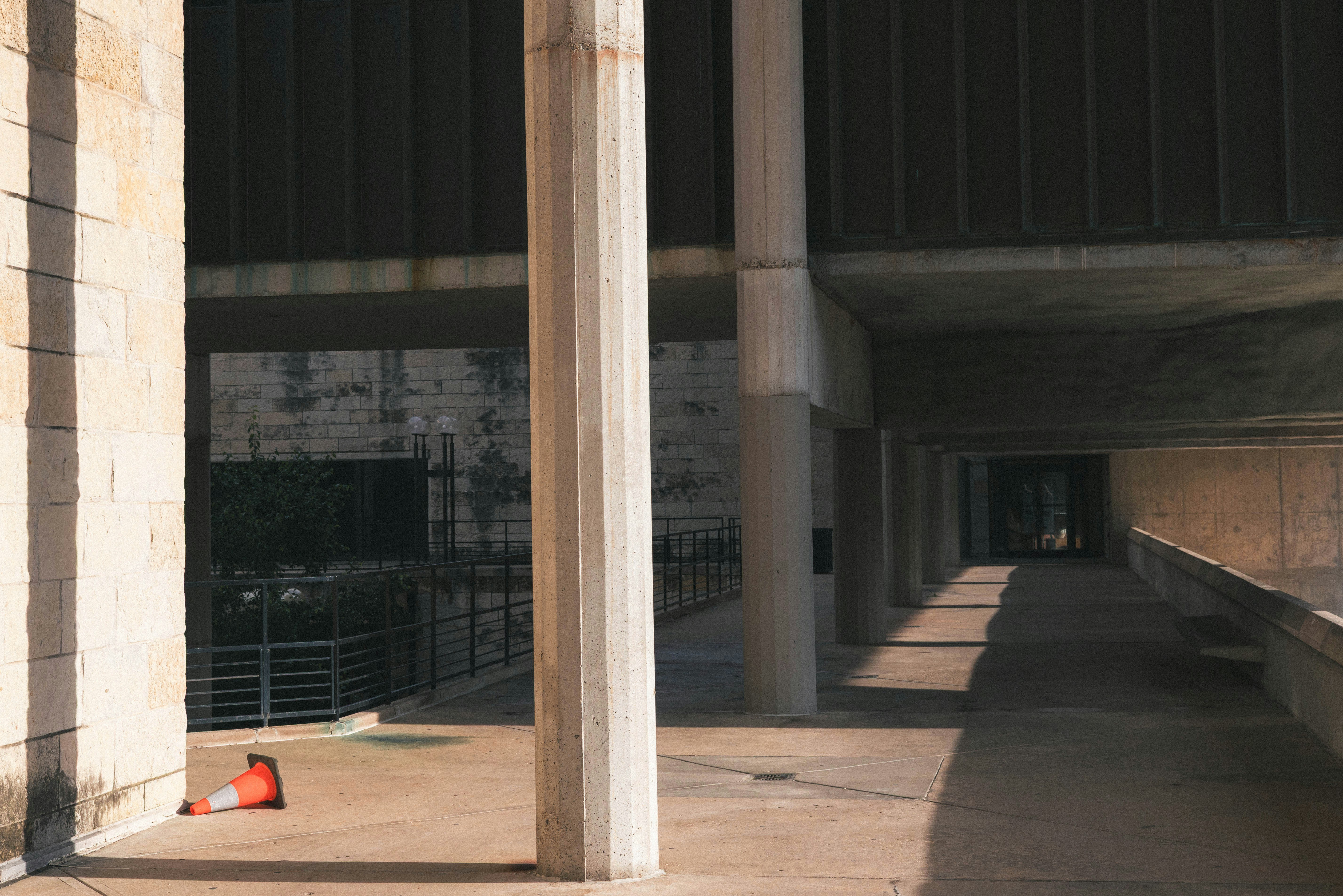 Concrete Canyon: Narrow Corridor Between Massive Columns