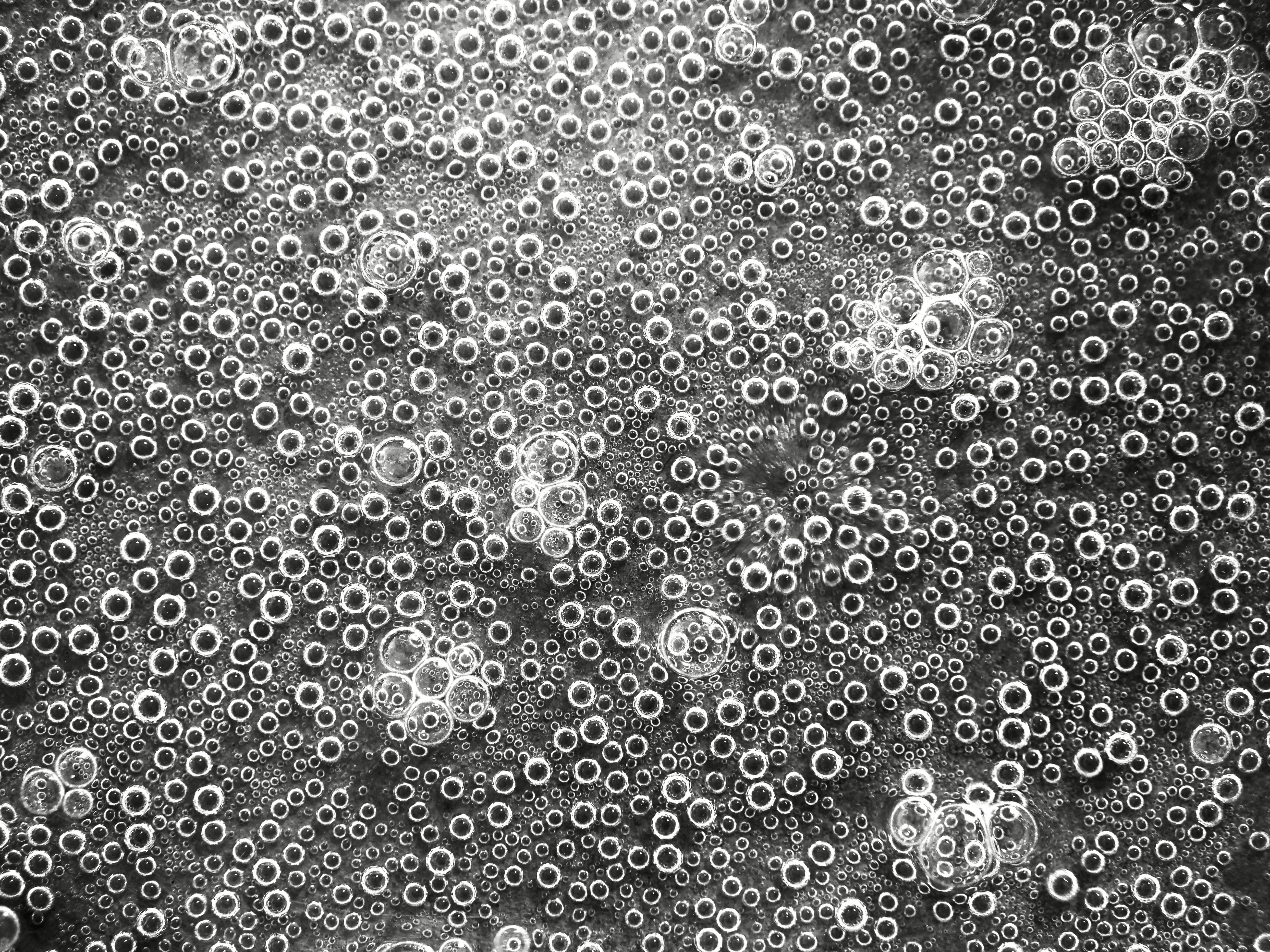 Macro view of densely packed circular bubbles forming a grayscale mosaic; a close-up texture study suitable for abstract patterns or materials texture analysis.