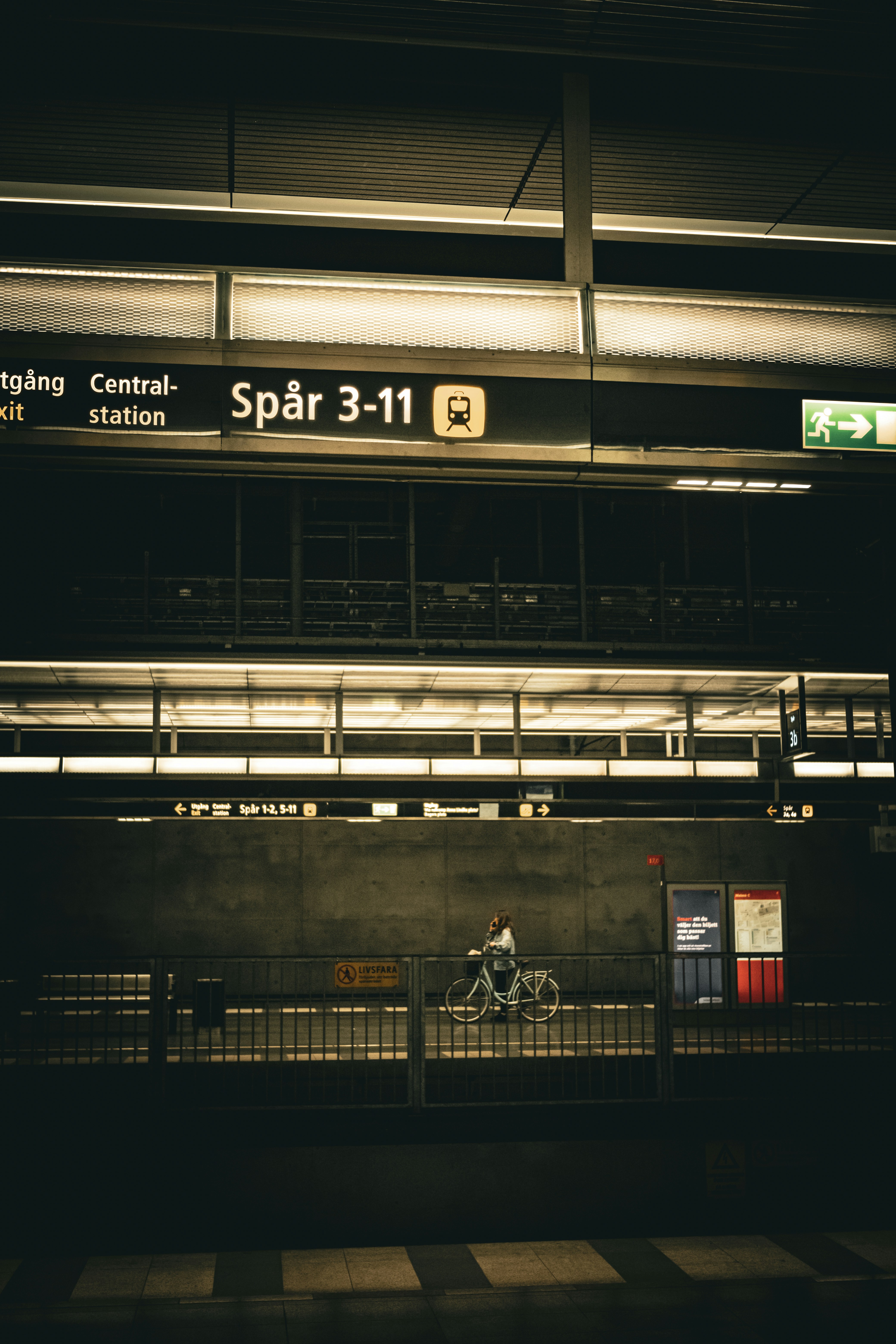 Midnight Platform: A Lone Rider Beneath Neon Signs