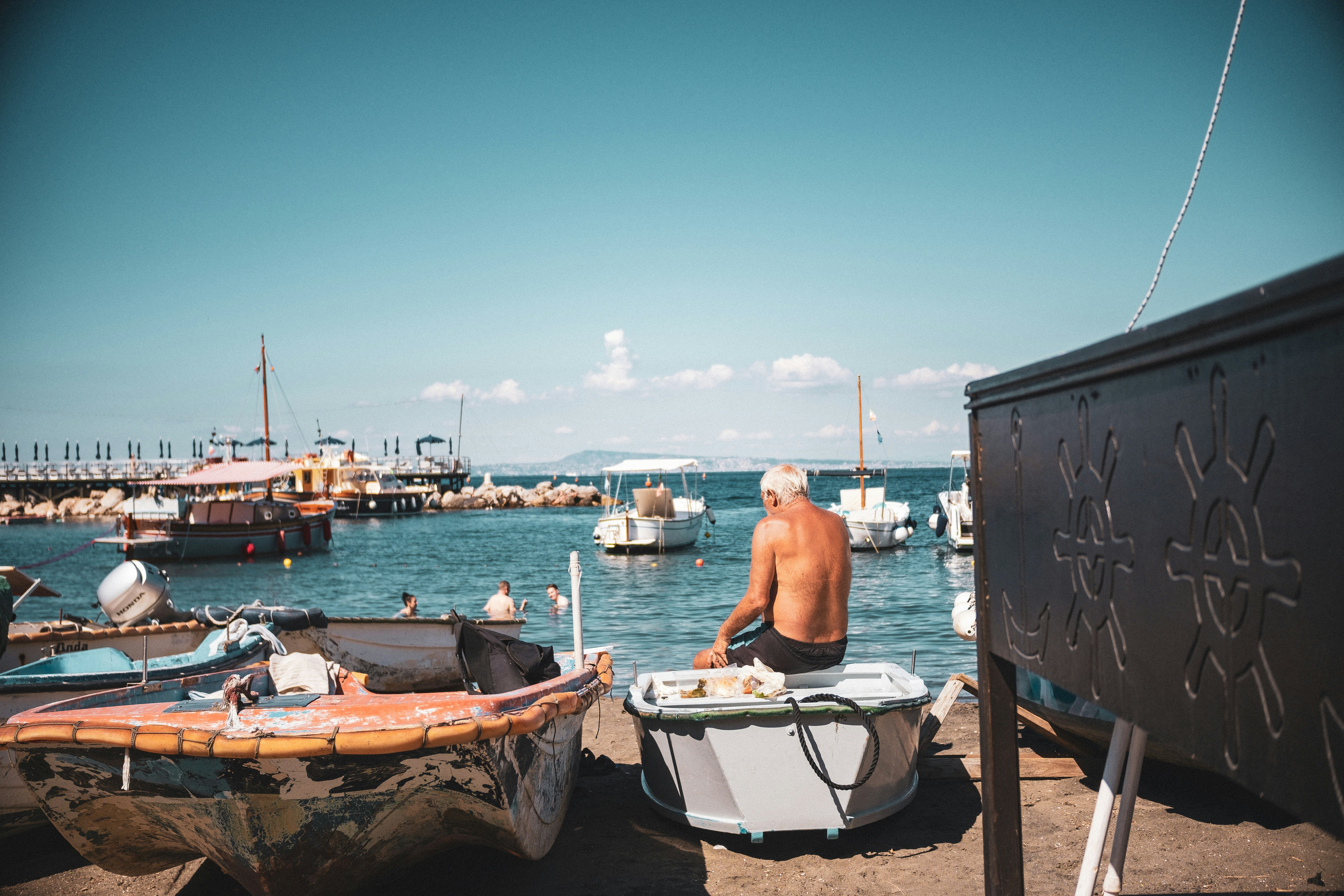 Harbor Worker at Dusk: Boats, Graffitied Dock, and Sea Breeze