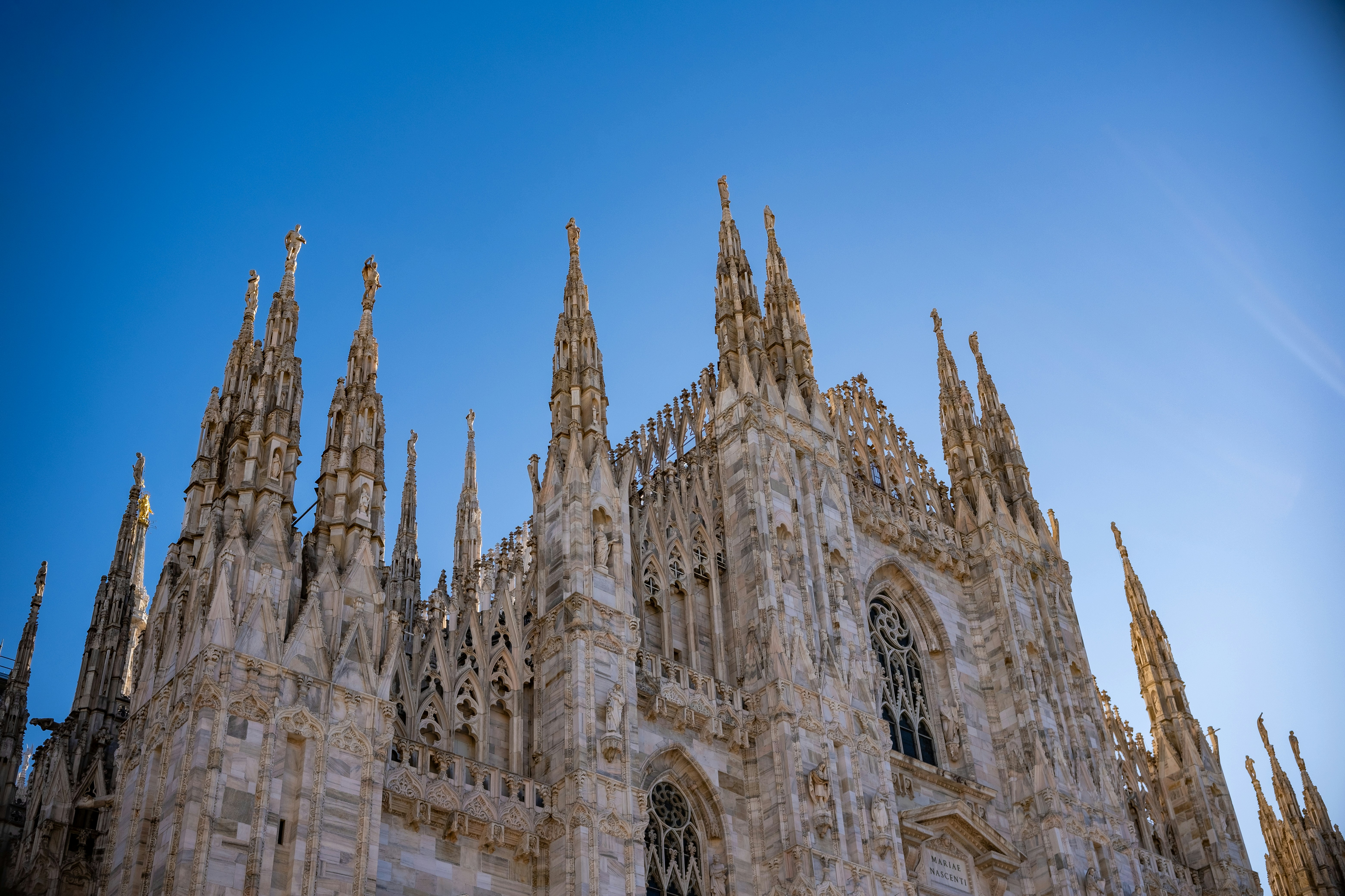 Gothic Elevation: Peaks of Stone Against a Clear Blue Sky