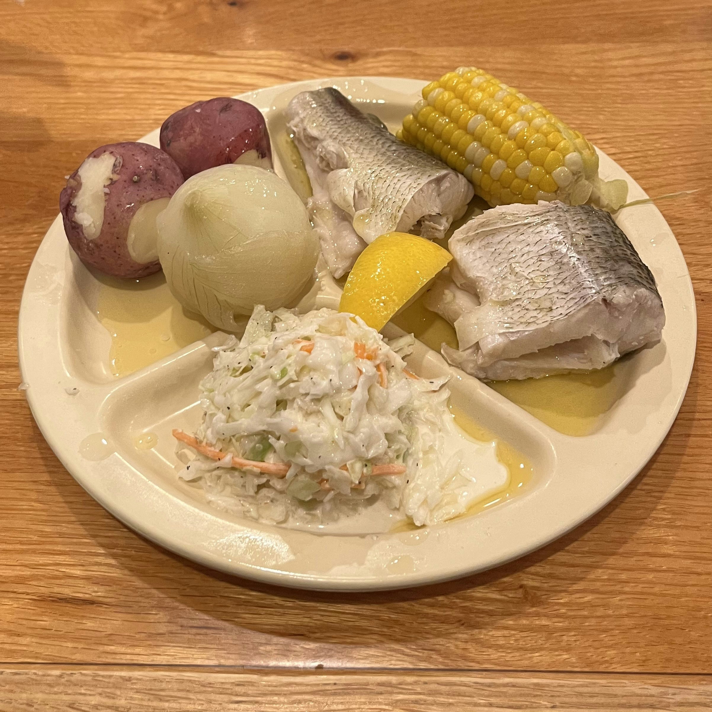 Seated Plate of Comfort: Varied Bites with Corn, Fish, and Slaw