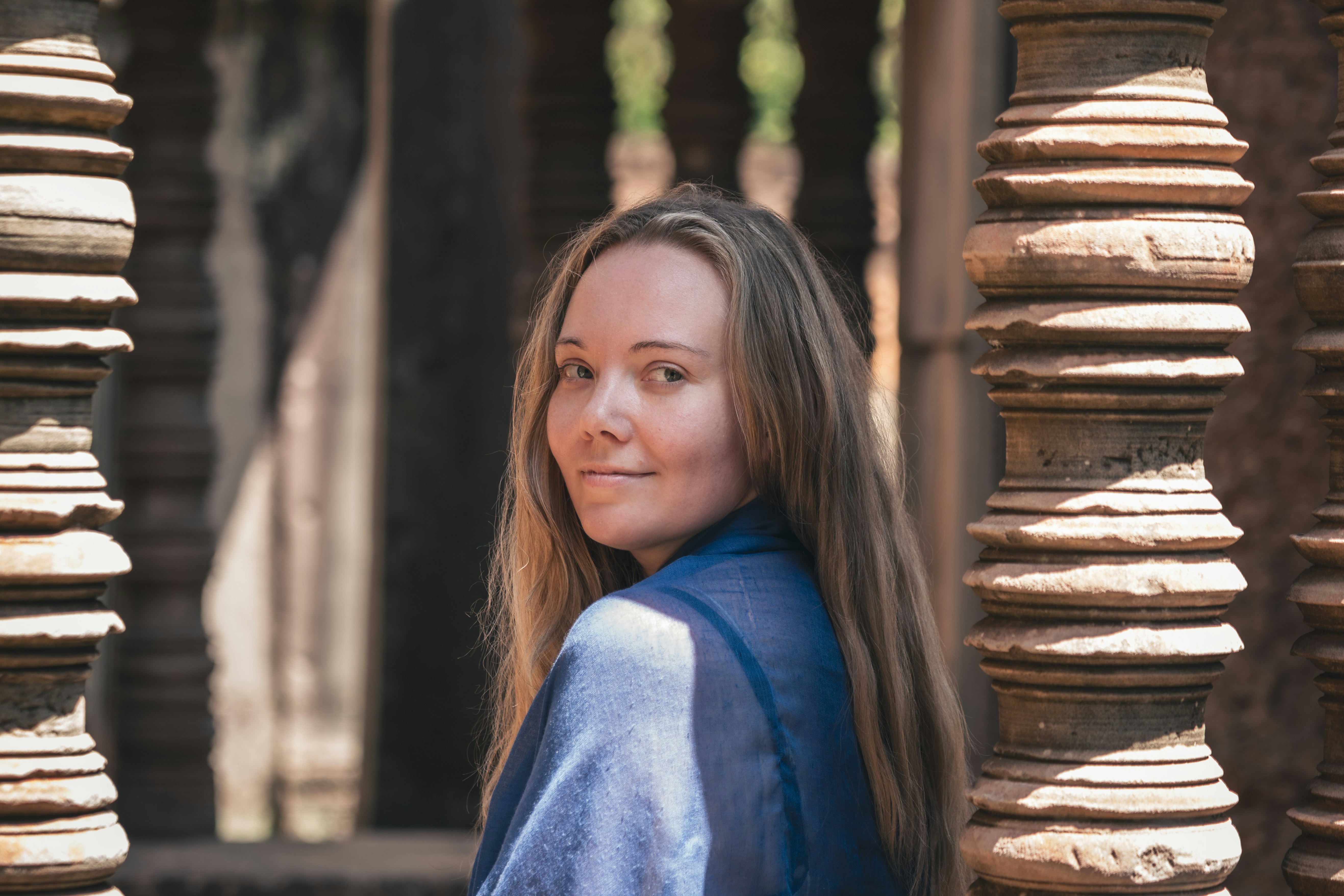 Carved Columns and a Quiet Gaze: Portrait Between Timeworn Pillars