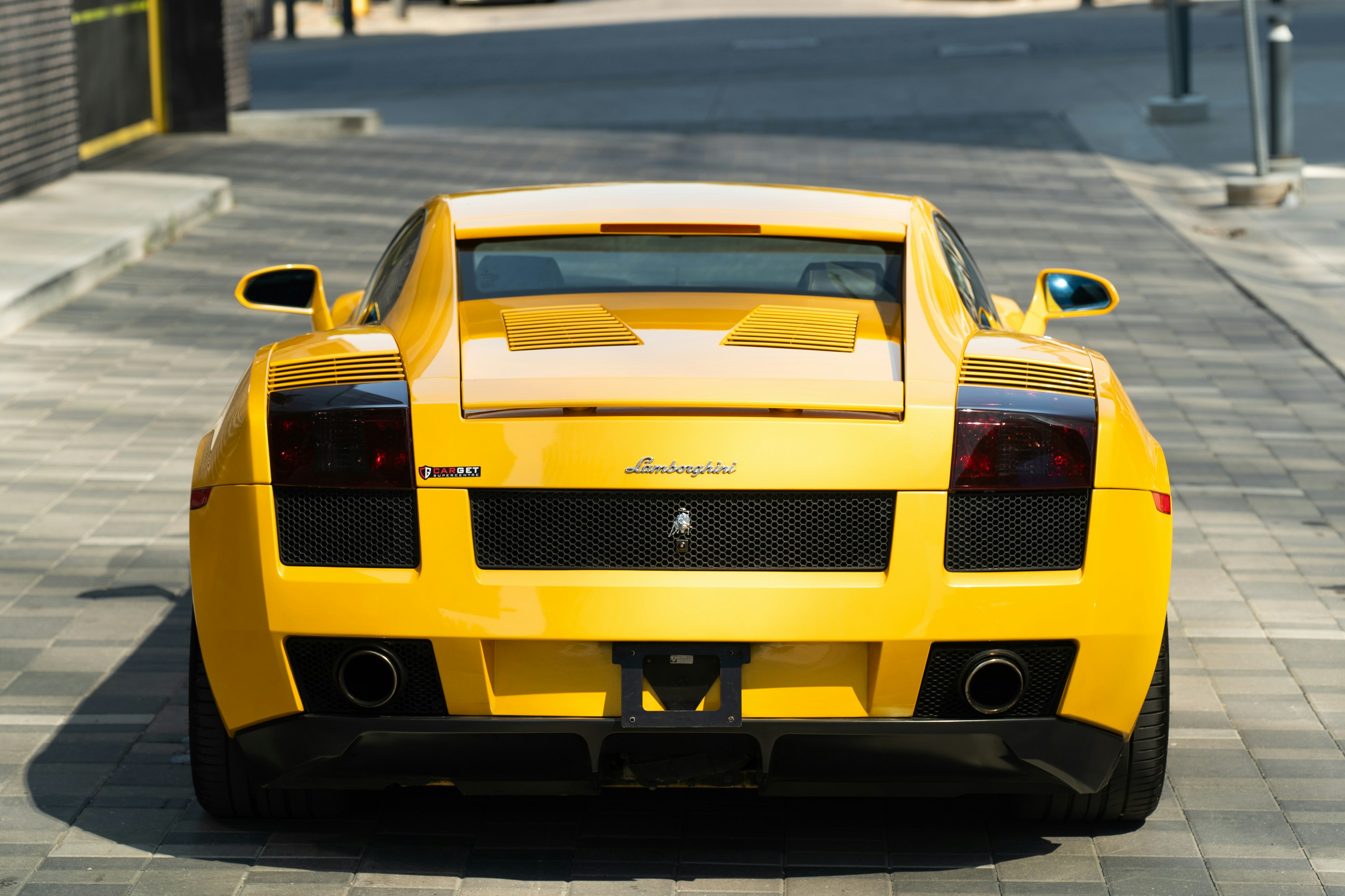 Sunlit Bull: The Yellow Lamborghini Huracán from the Back
