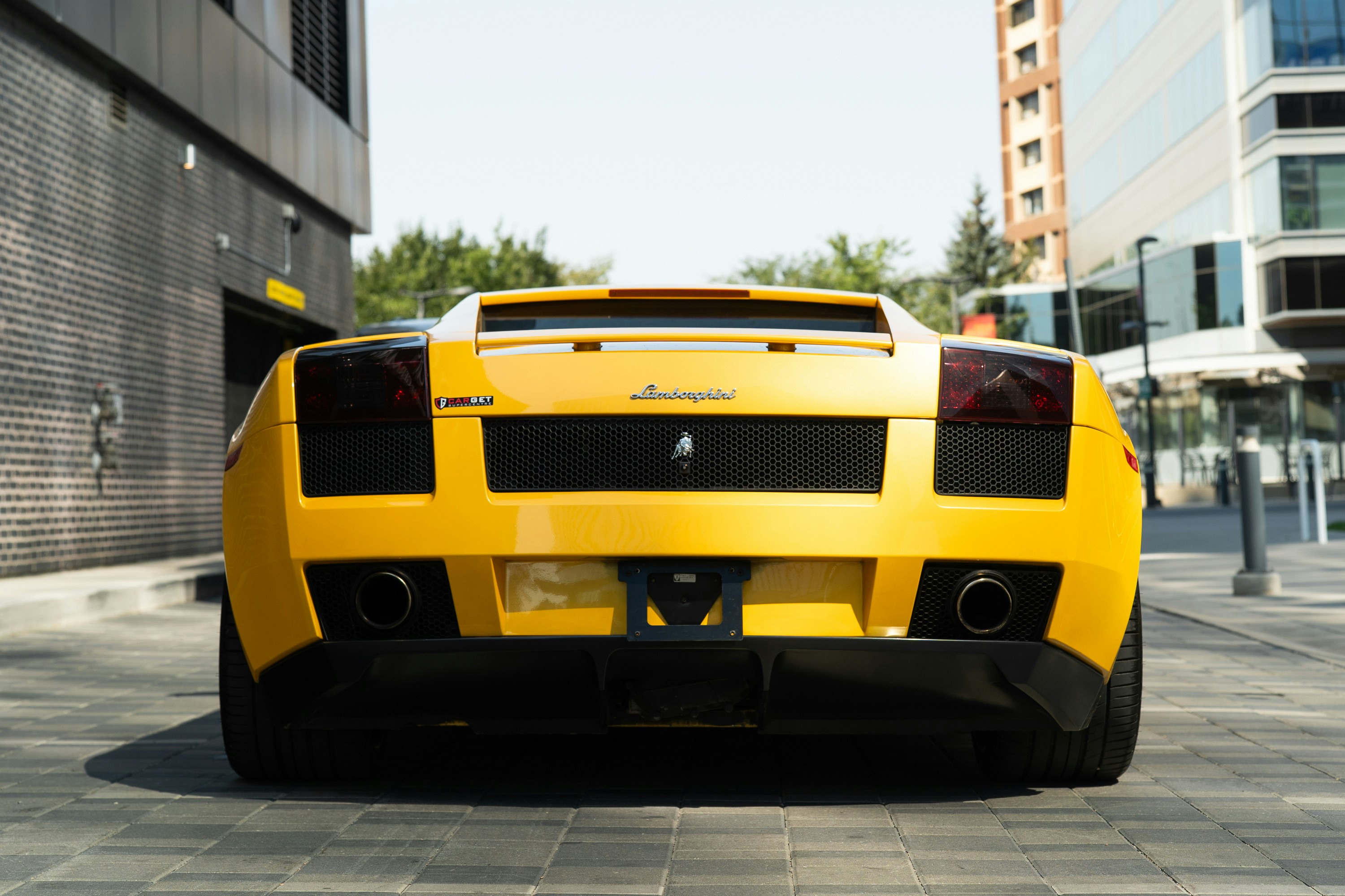Luminous Bolt: Back View of a Yellow Lamborghini in an Urban Corridor