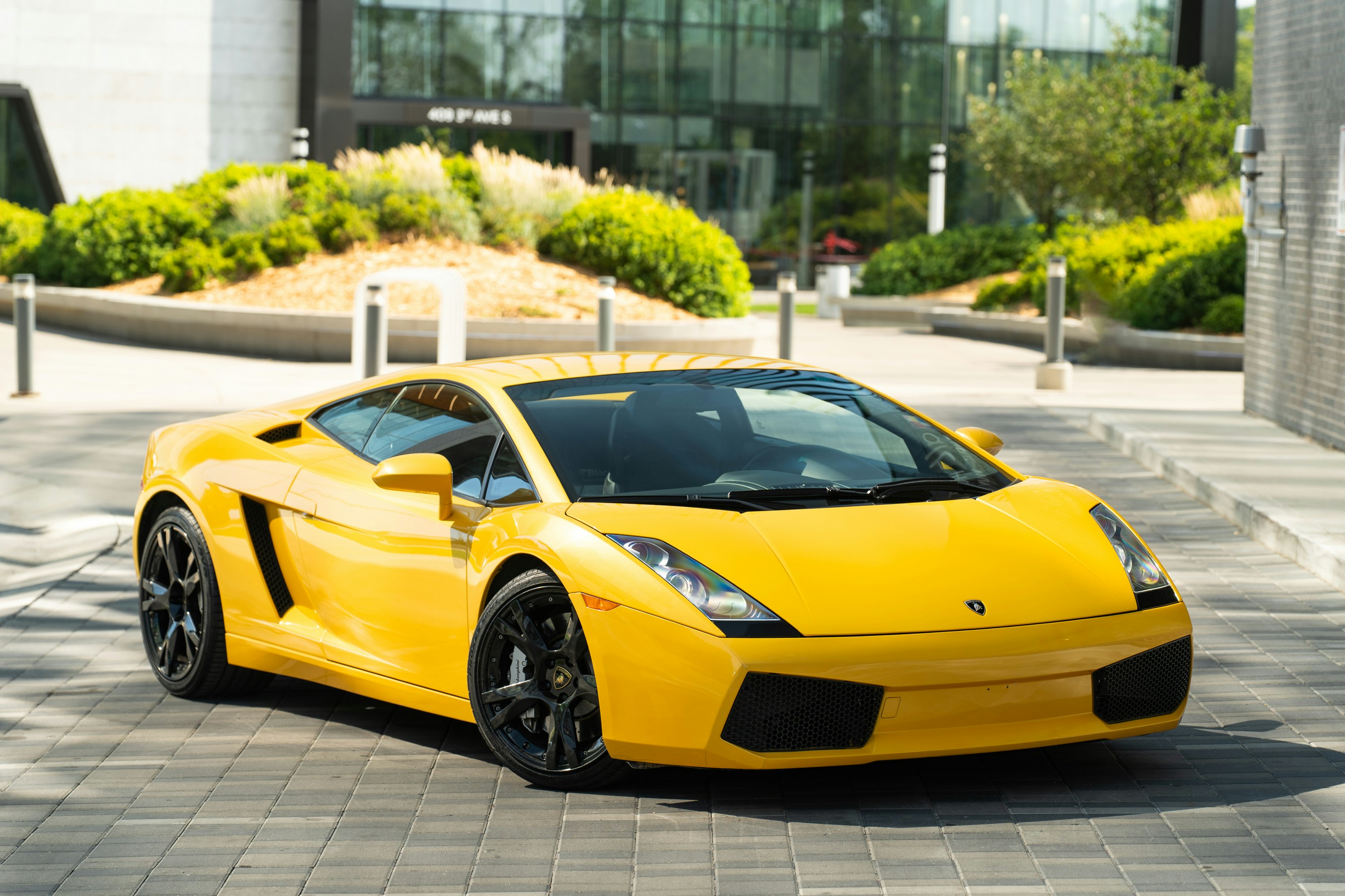 Sunlit Yellow Diablo: A Vivid Precision Shot of a Lamborghini in Urban Pedestal