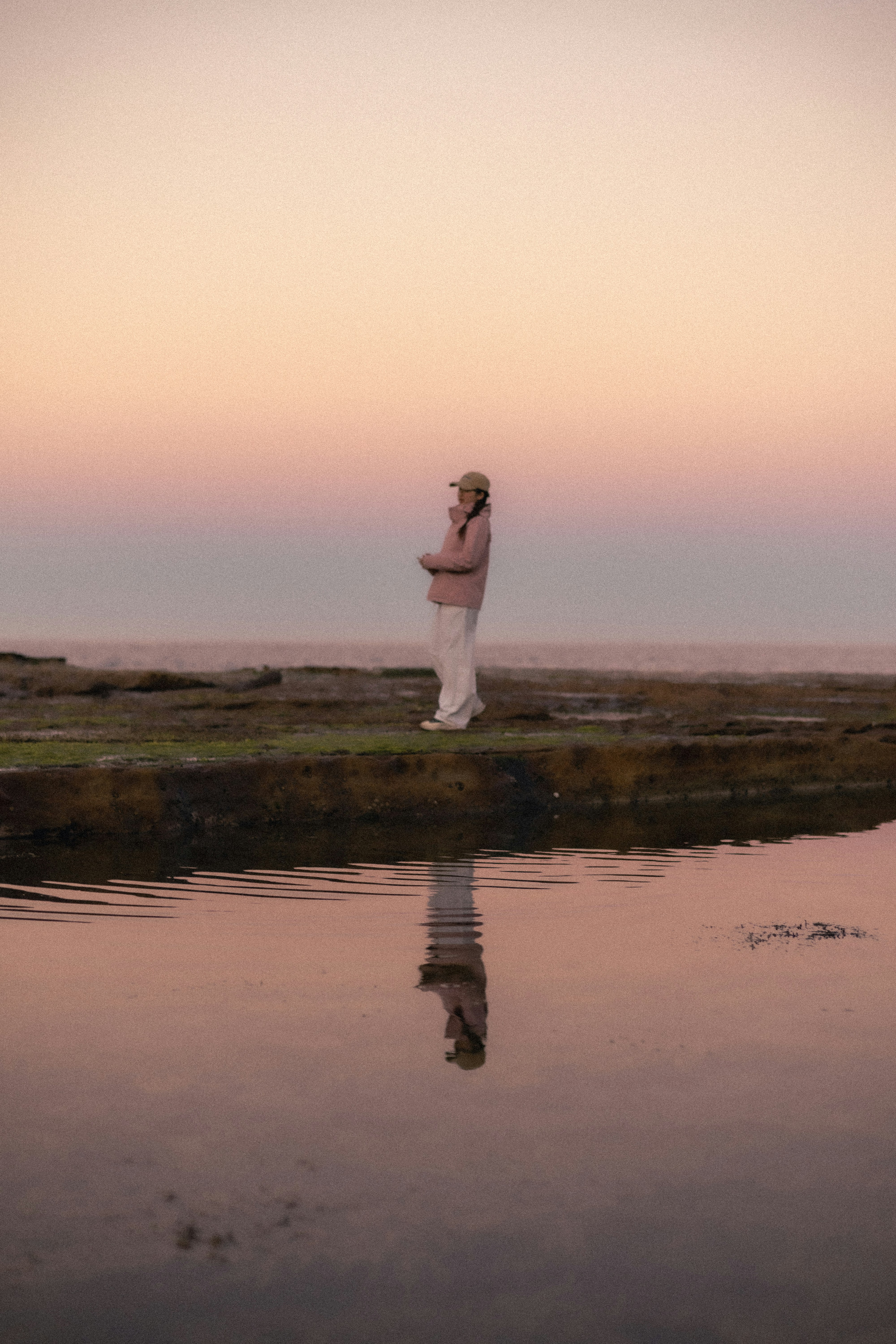 Silent Seaside Figure: A Solitary Moment at Dusk