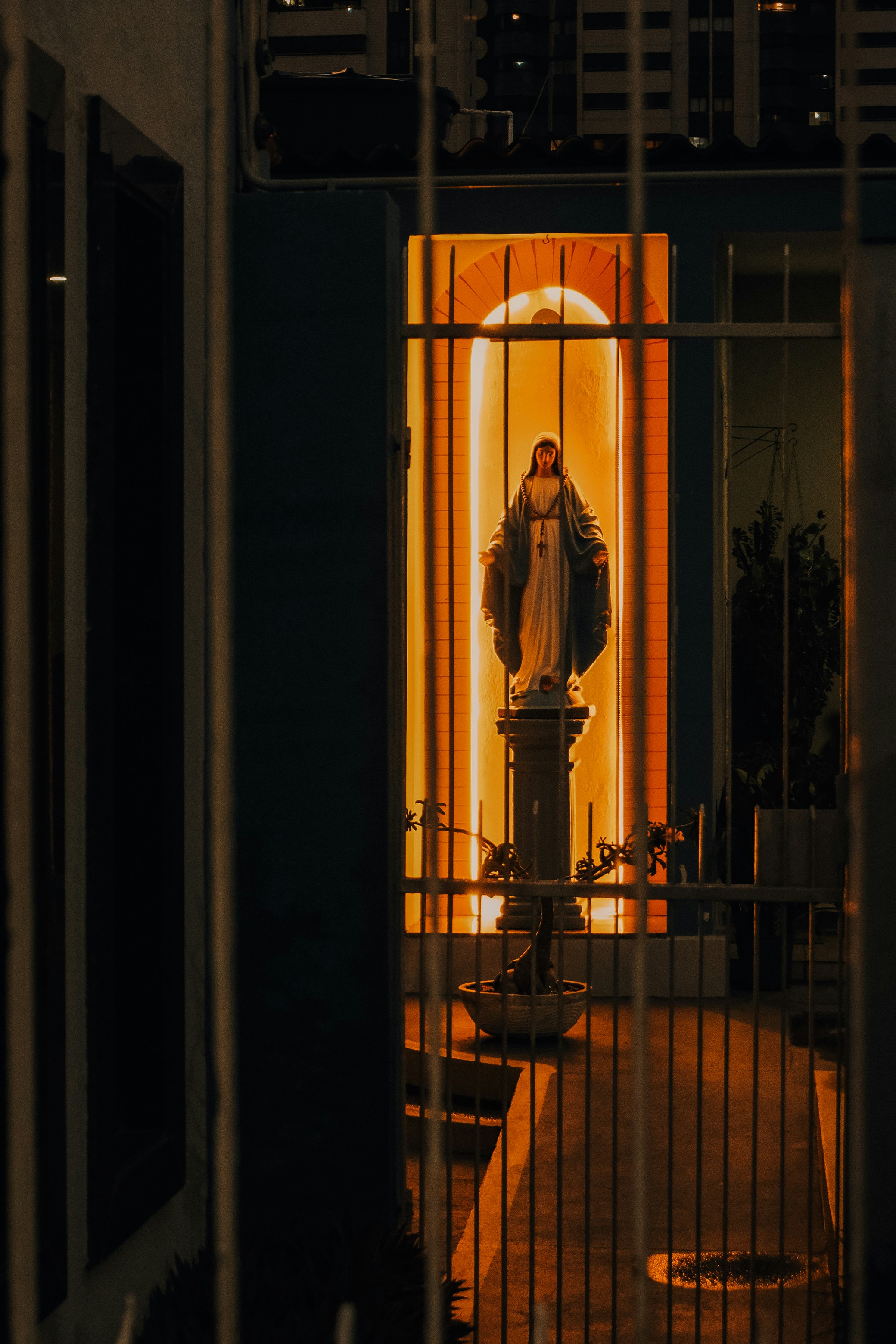 Glowing halo: a statue framed within a golden niche