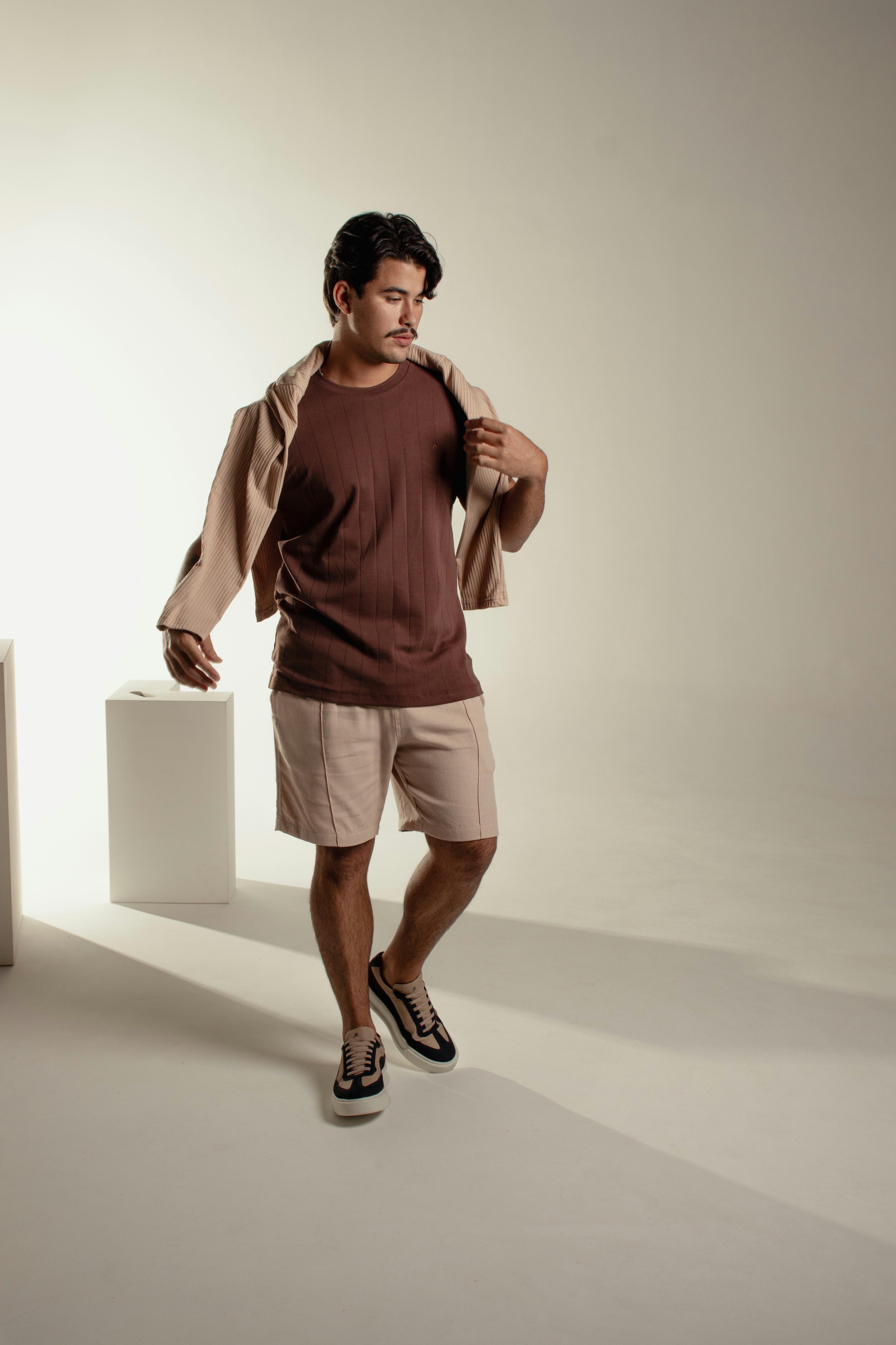 Casual Movement: A Man in Neutral Tones Steps into the Light