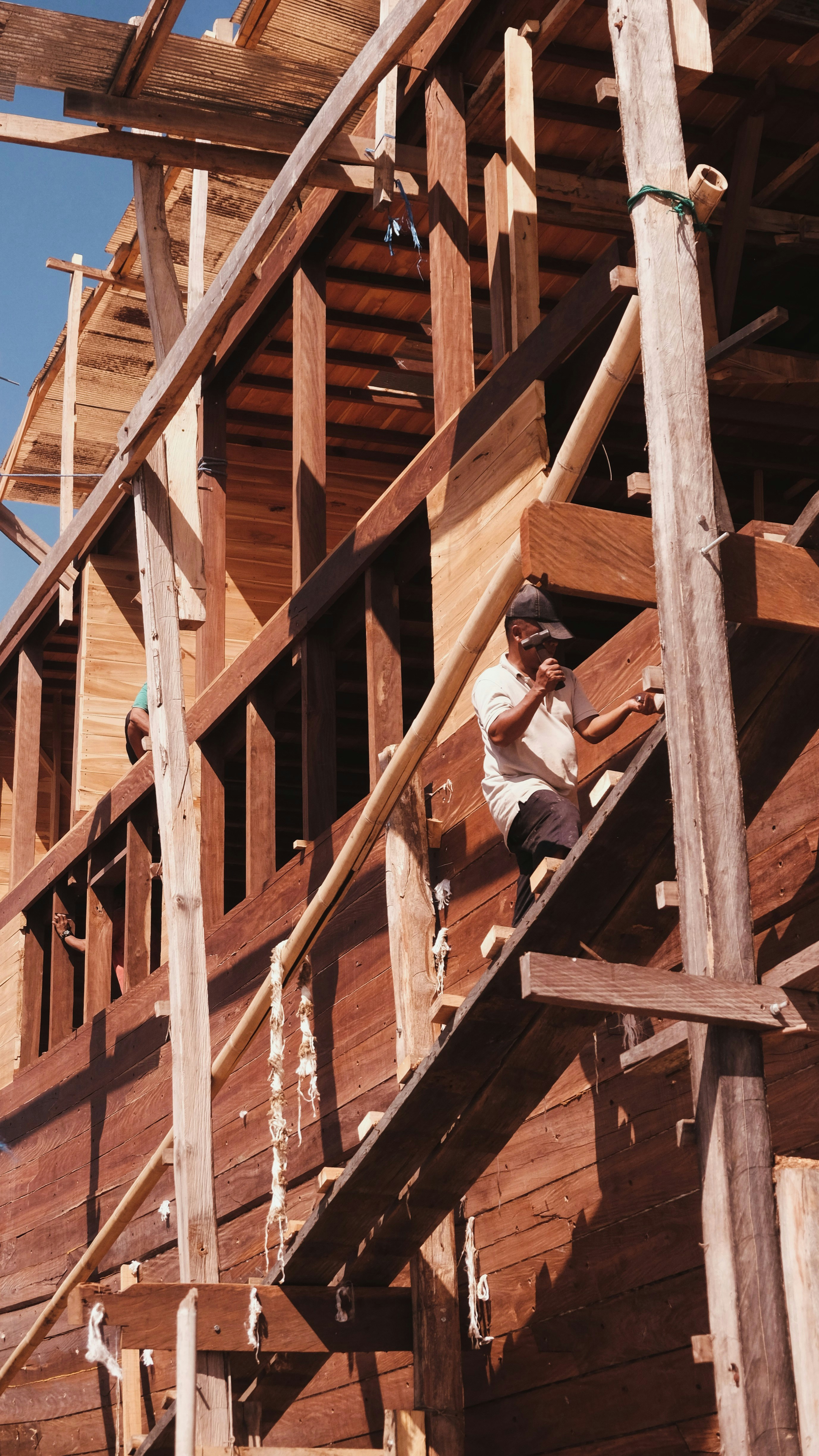 Riser of Wood: Worker Scaling a Timber Staircase under Construction