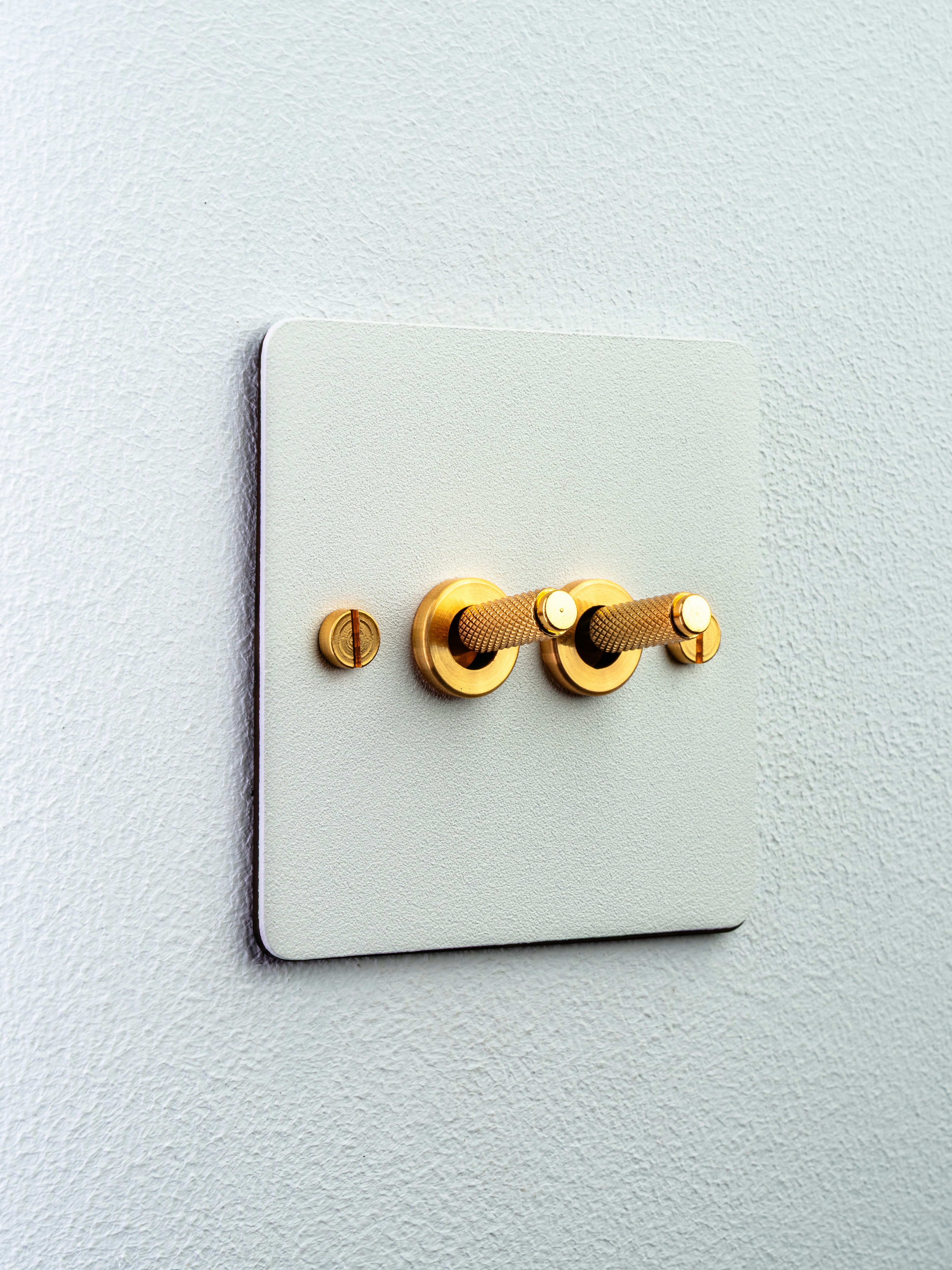 Golden Knobs on a Quiet Gray Wall