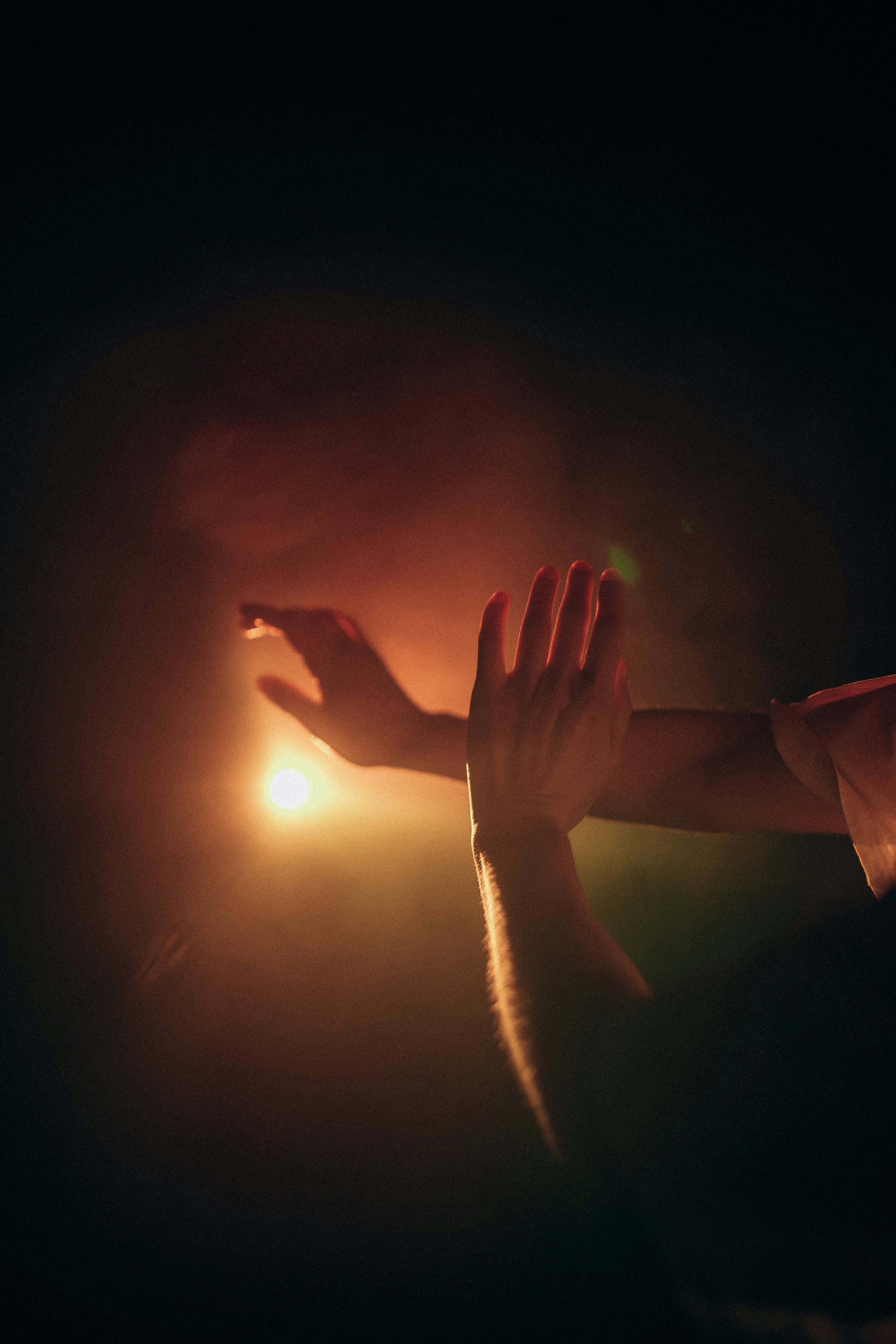 Hands in Motion: A Glowing Pause Amid Quiet Night