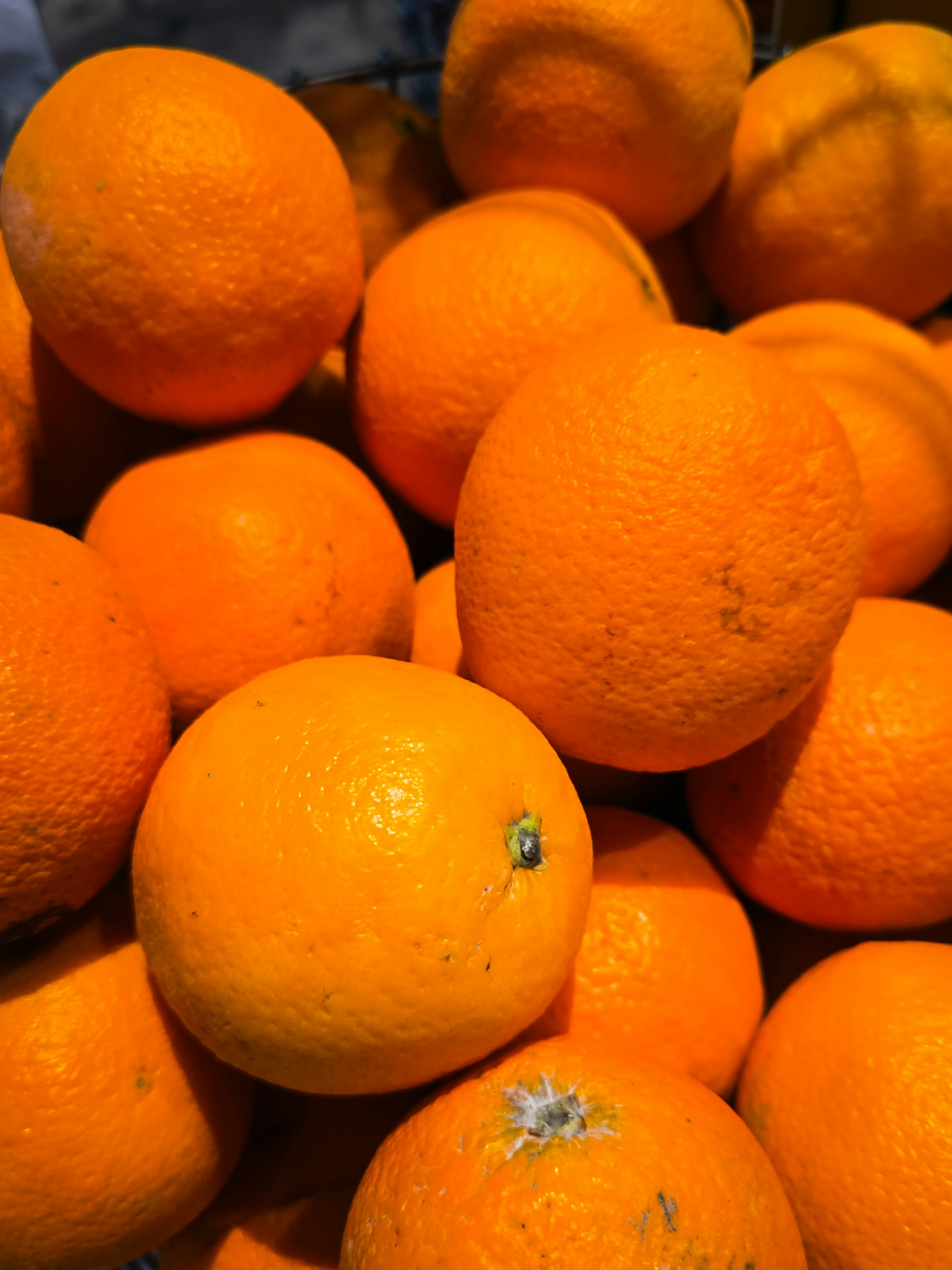 Citrus Mosaic: A Close-Held Glimpse of Oranges in Sunset Hue