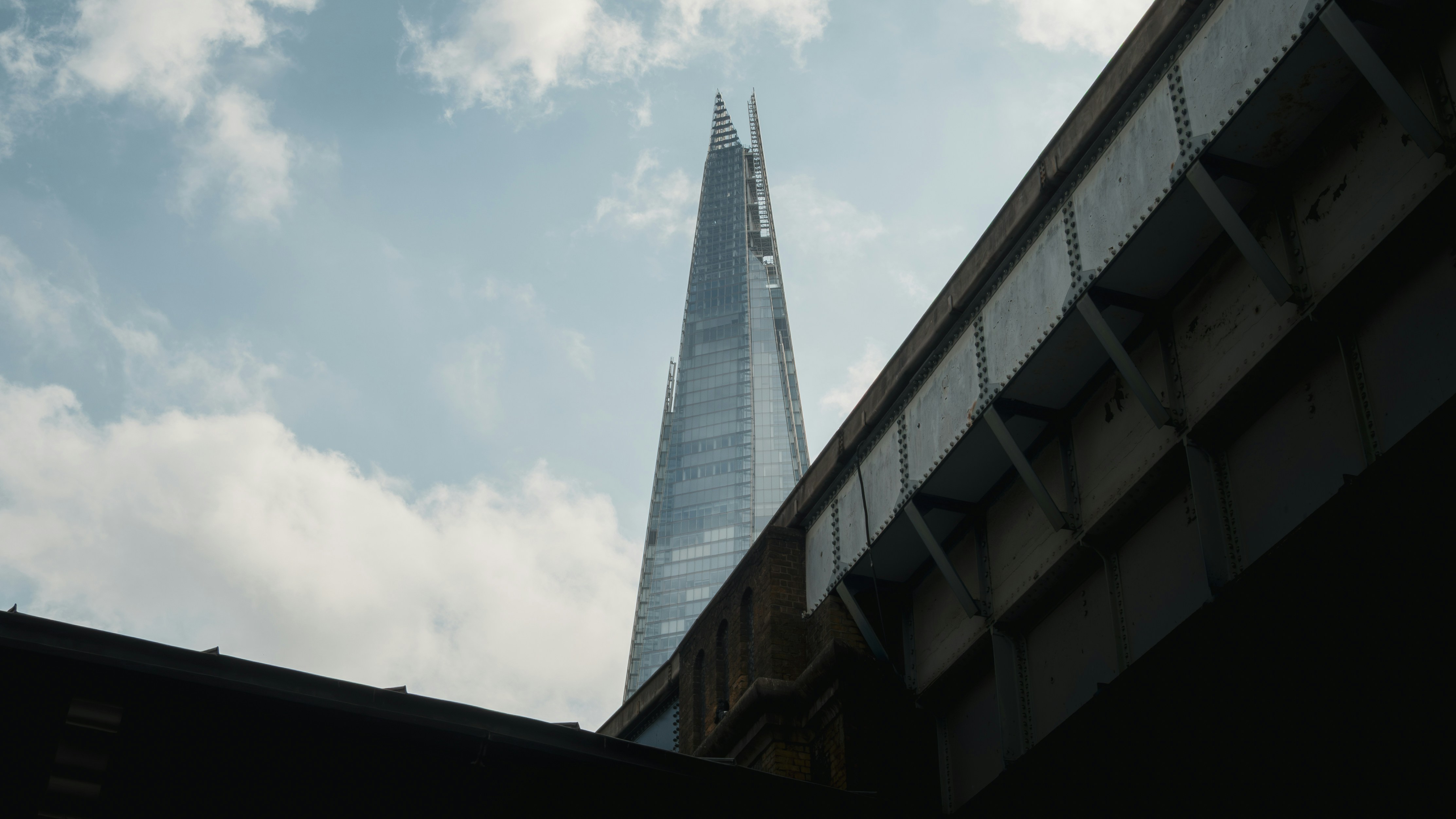 Skyward Needle: The Shard Piercing Above Old Brick and Steel