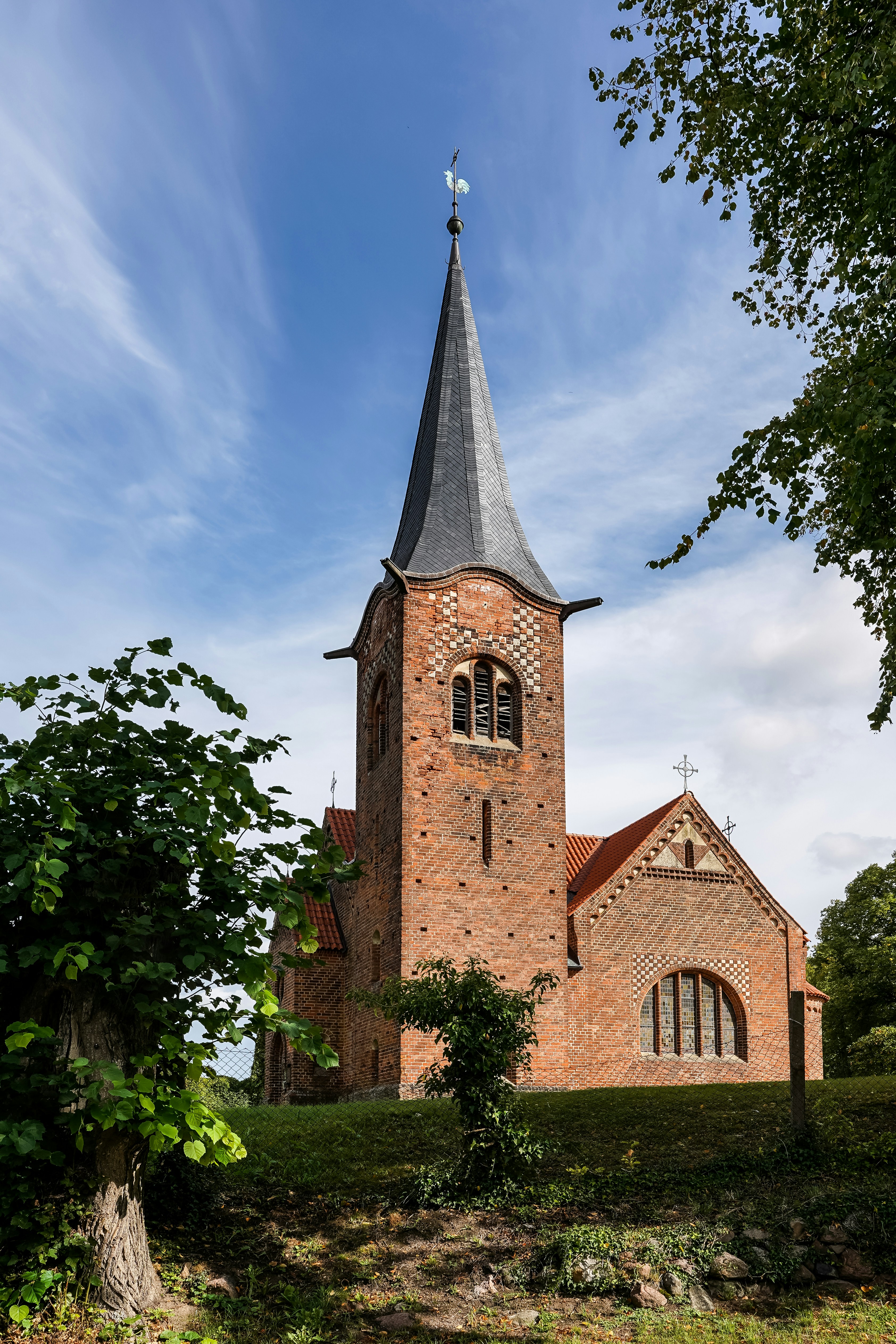 Brick Church Tower Reaching Toward a Clear Sky
